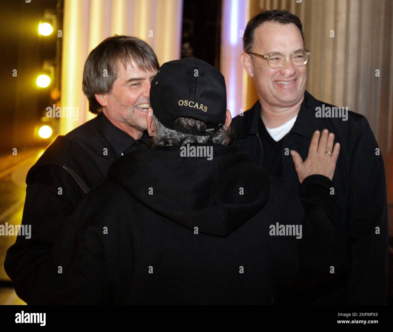 Actor Tom Hanks, right, is seen with stage managers David Wader, center ...