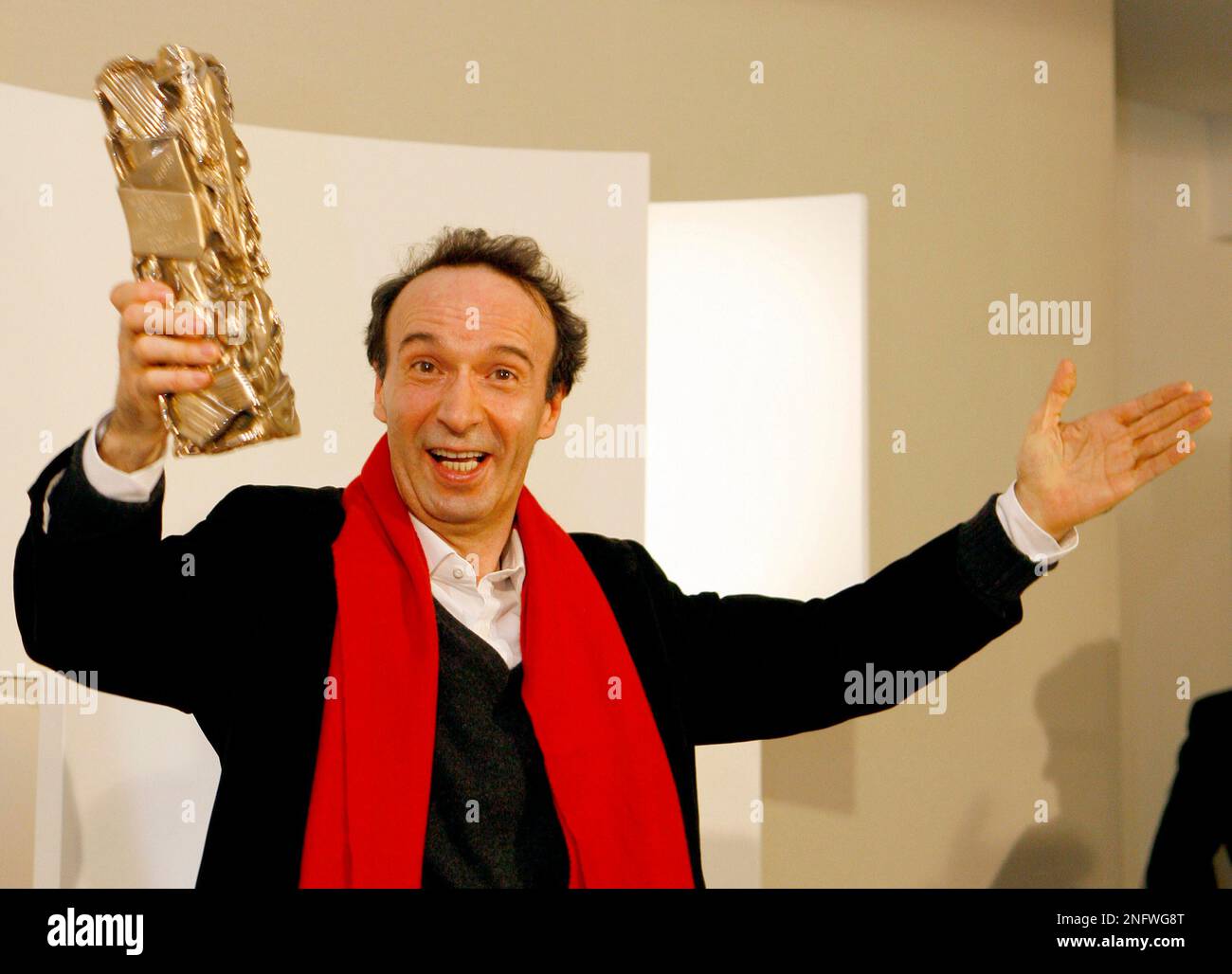 Italian director and actor Roberto Benigni reacts after receiving the ...
