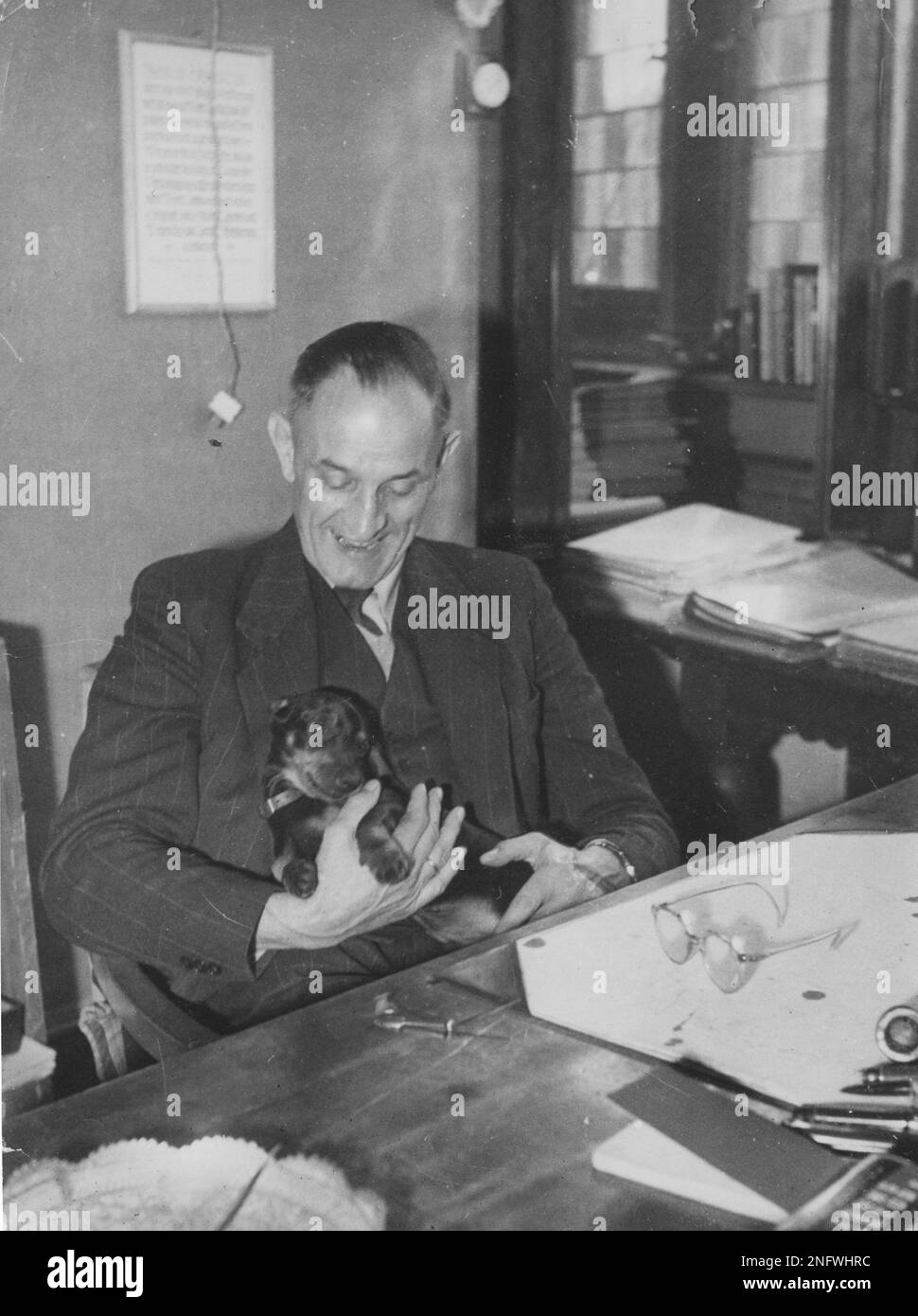 Reverend Martin Niemoeller, holds the family dog "Ratzel", a Dachshund ...