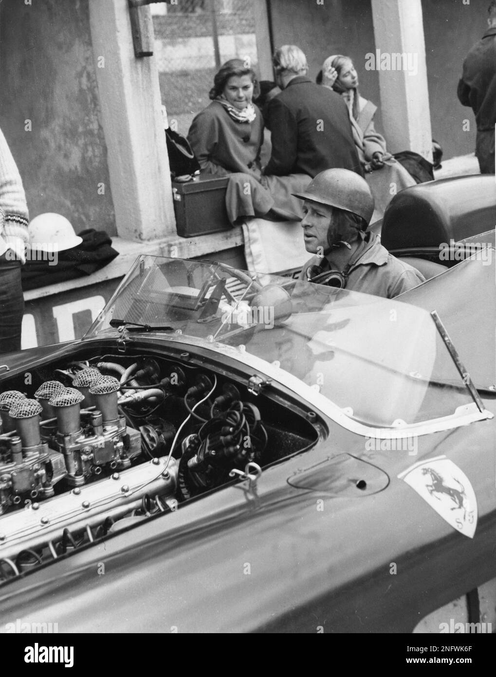 Driver Peter Collins from Great Britain sits in his Ferrari racing car ...