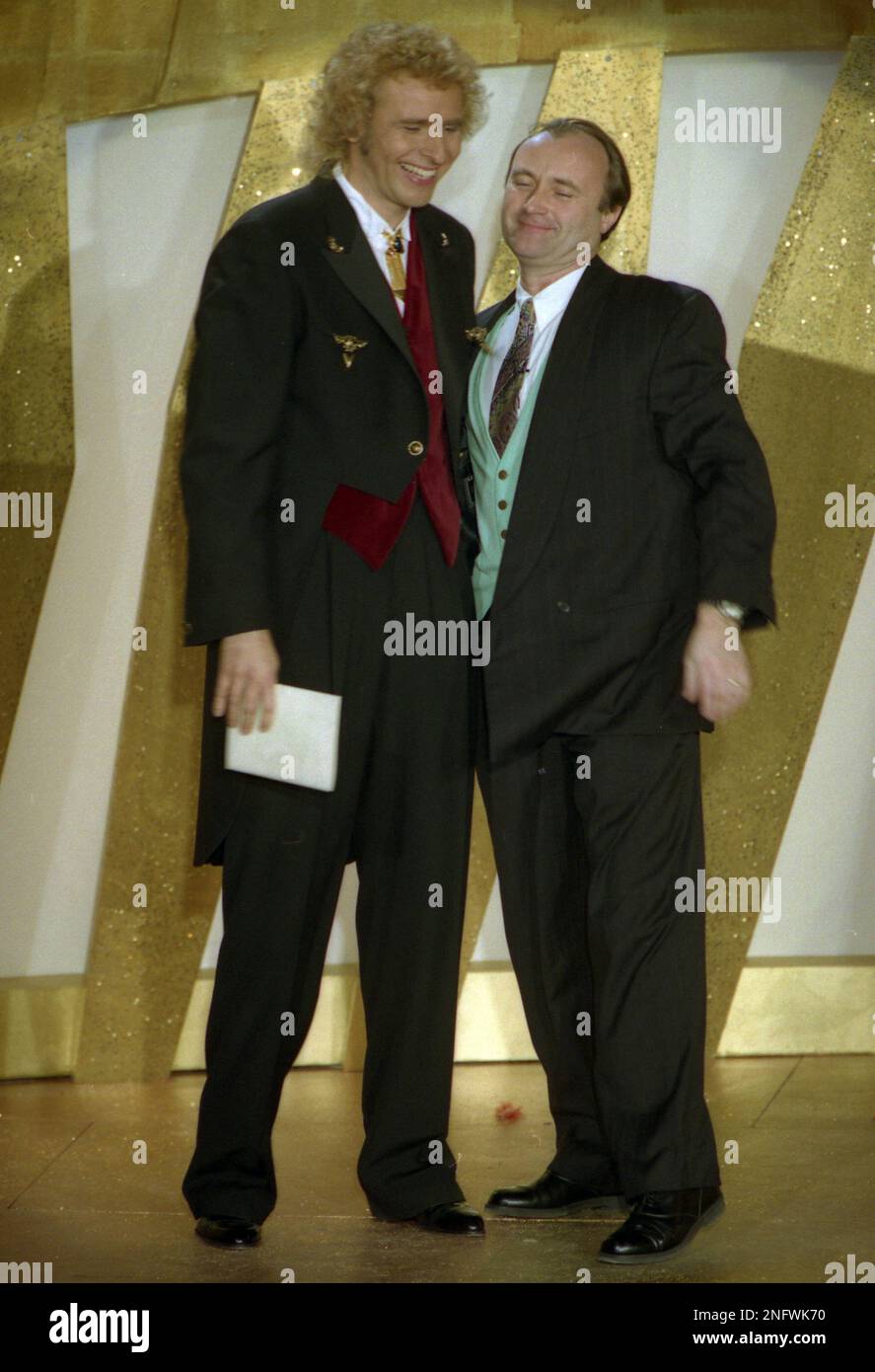 German presenter Thomas Gottschalk, left, embraces British singer Phil ...