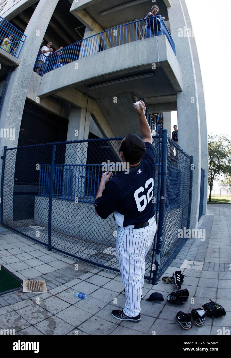 New York Yankees pitcher Joba Chamberlain throws an autographed ball ...