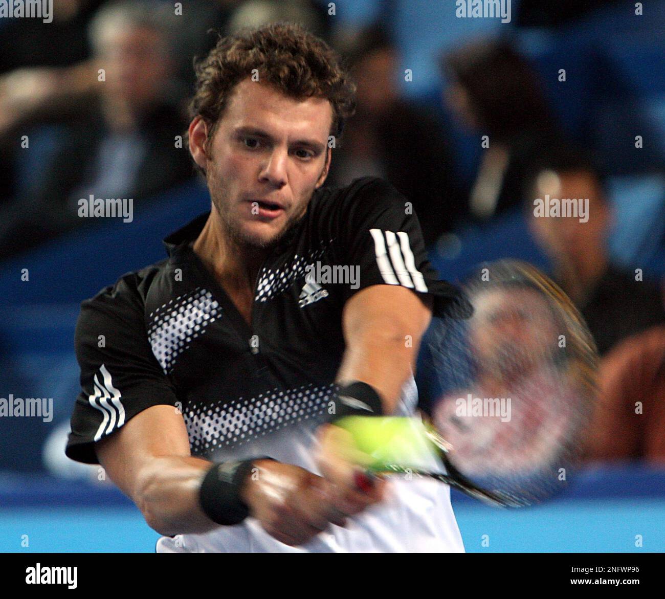 France's Paul-Henri Mathieu returns a ball to France's Gilles Simon ...