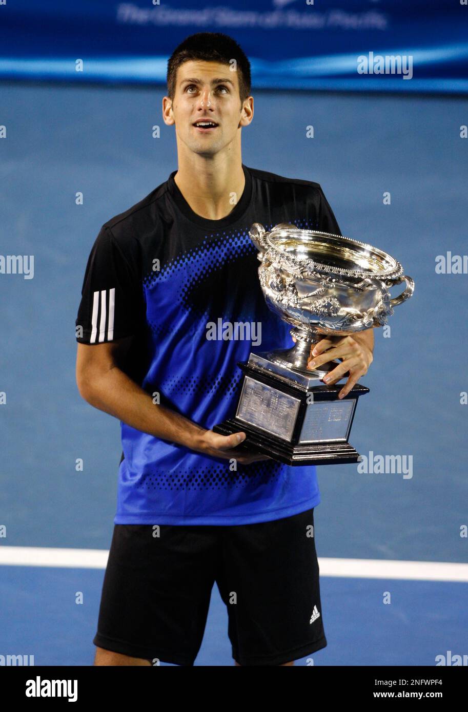 Serbia's Novak Djokovic holds a trophy after winning the final of the ...