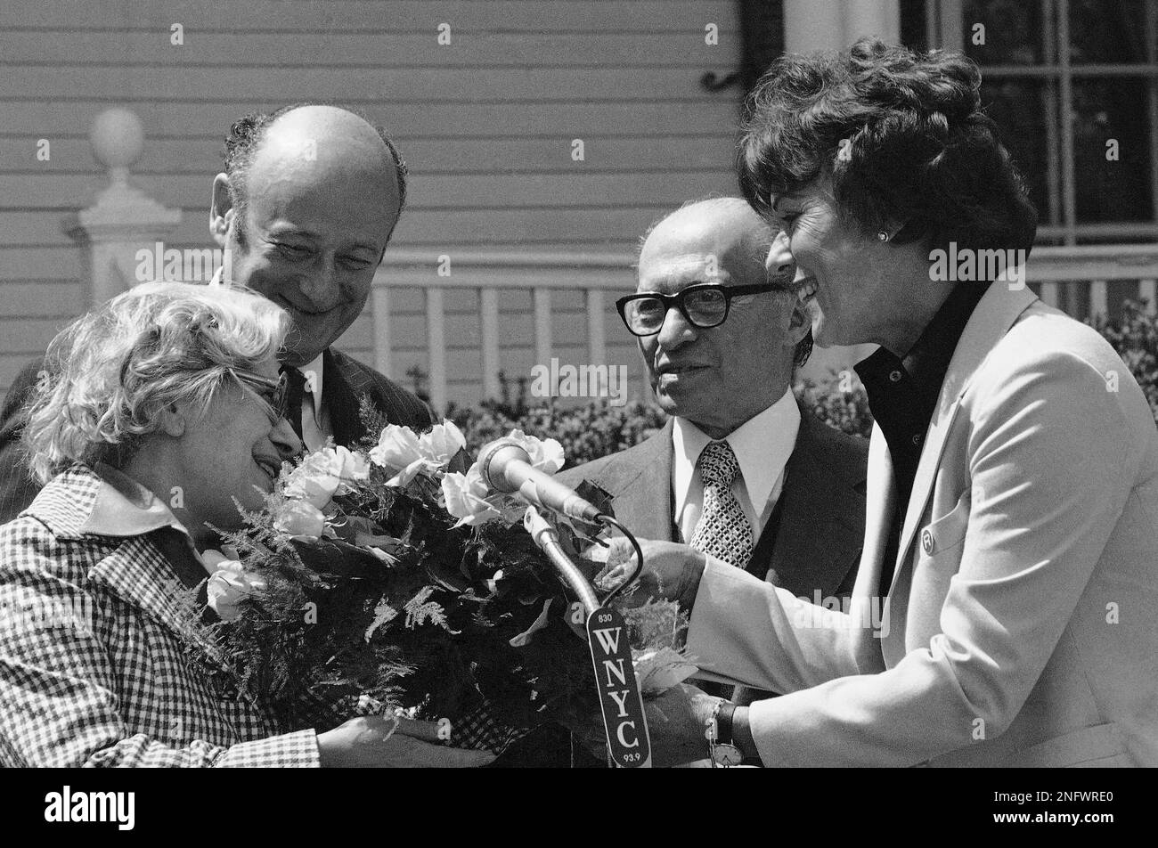 Bess Myerson, hands a Bouquet of roses to Mrs. Aliza Begin, wife of ...