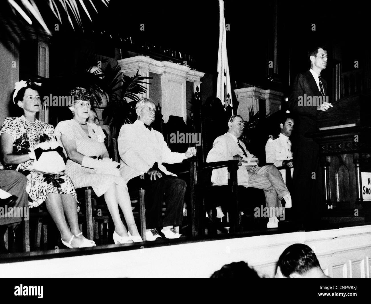 John F. Kennedy speaking as his family sits behind him during a ...