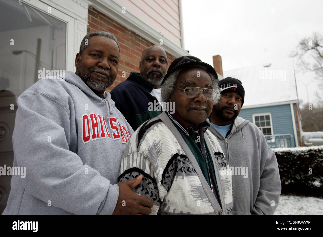 Henry Bolden Jr., second from right, stand in front of his home in ...
