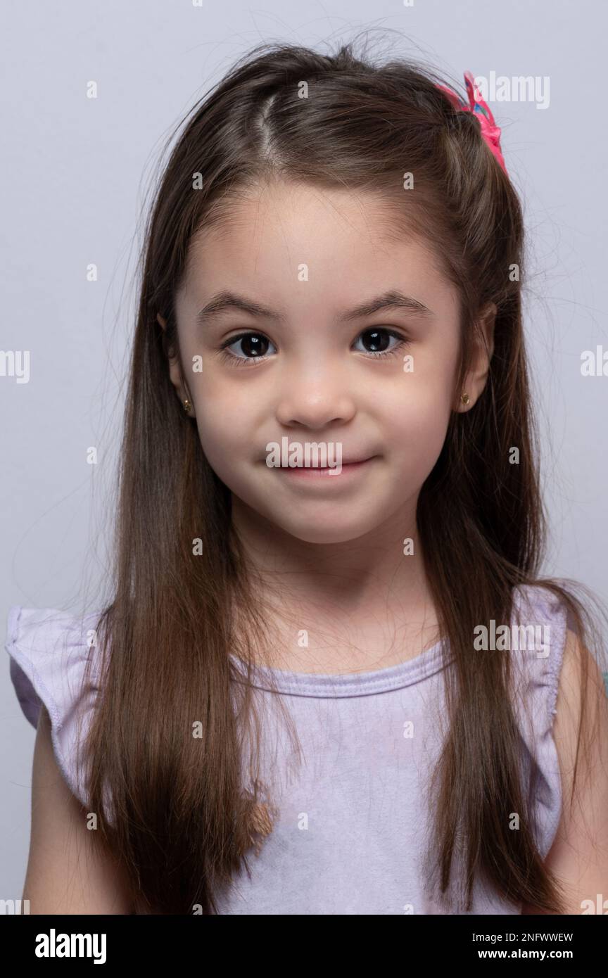 Portrait of kid caucasian girl looking straight forward Stock Photo - Alamy