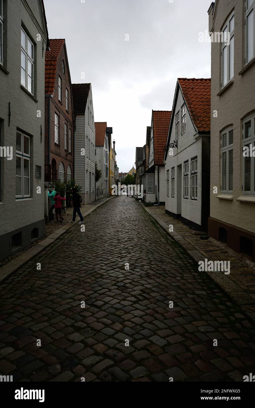 A street between modern houses under the cloudy sky Stock Photo - Alamy