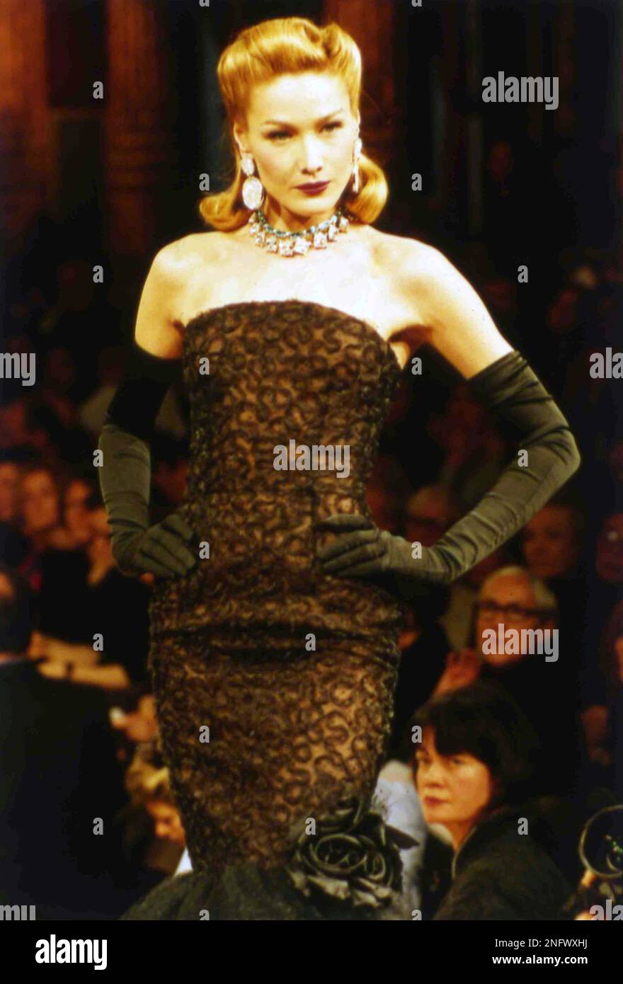Italian model Carla Bruni presents a long dark lace sleeveless eveing ...