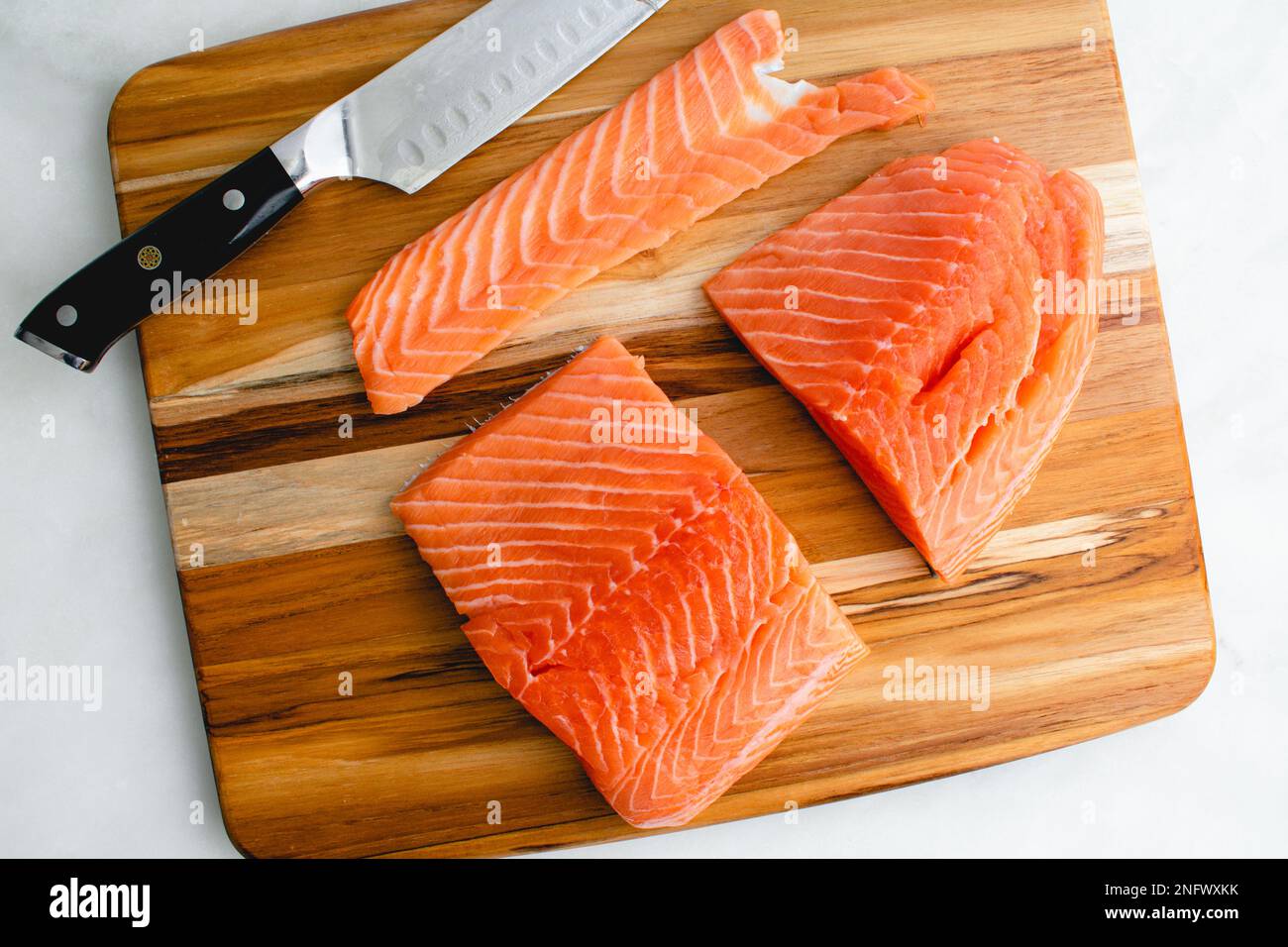 Raw Salmon Fillet Sliced into Three Pieces: Uncooked fish fillet spiced ...