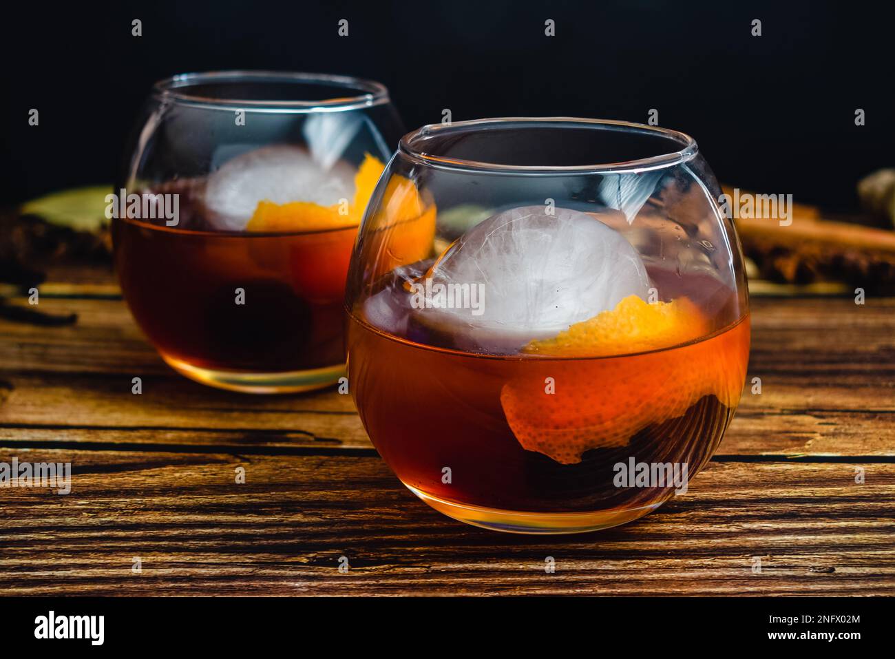 Spiced Old Fashioned Cocktail in a Balloon Glass With an Ice Sphere ...