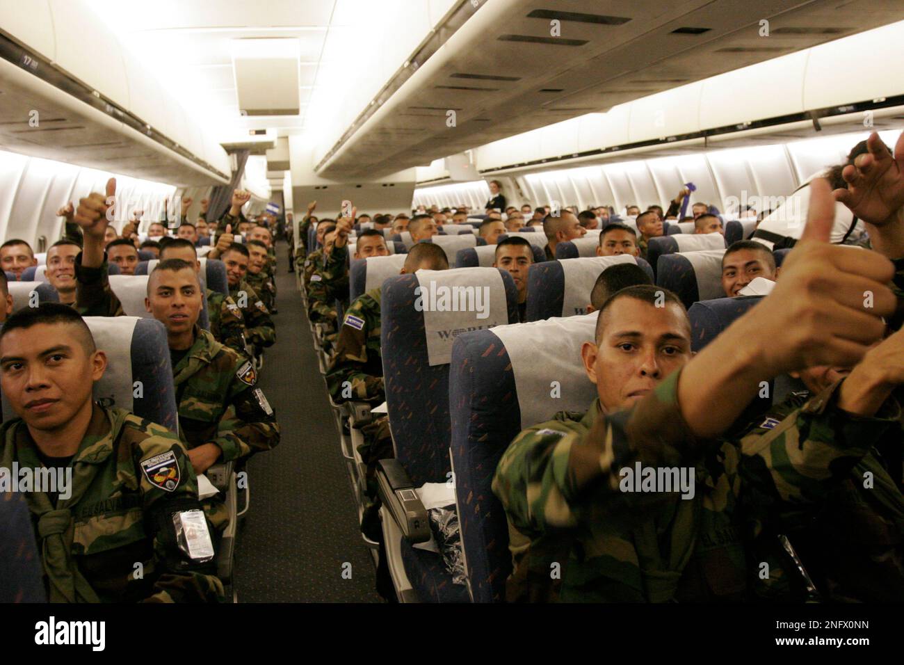 Salvadorian soldiers from the Cuscatlan battalion sit in a plane at the ...