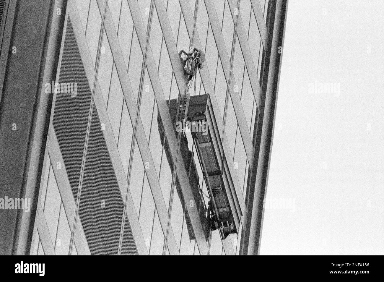 Daniel Goodwin, climber, with a scaffolding following himas ...