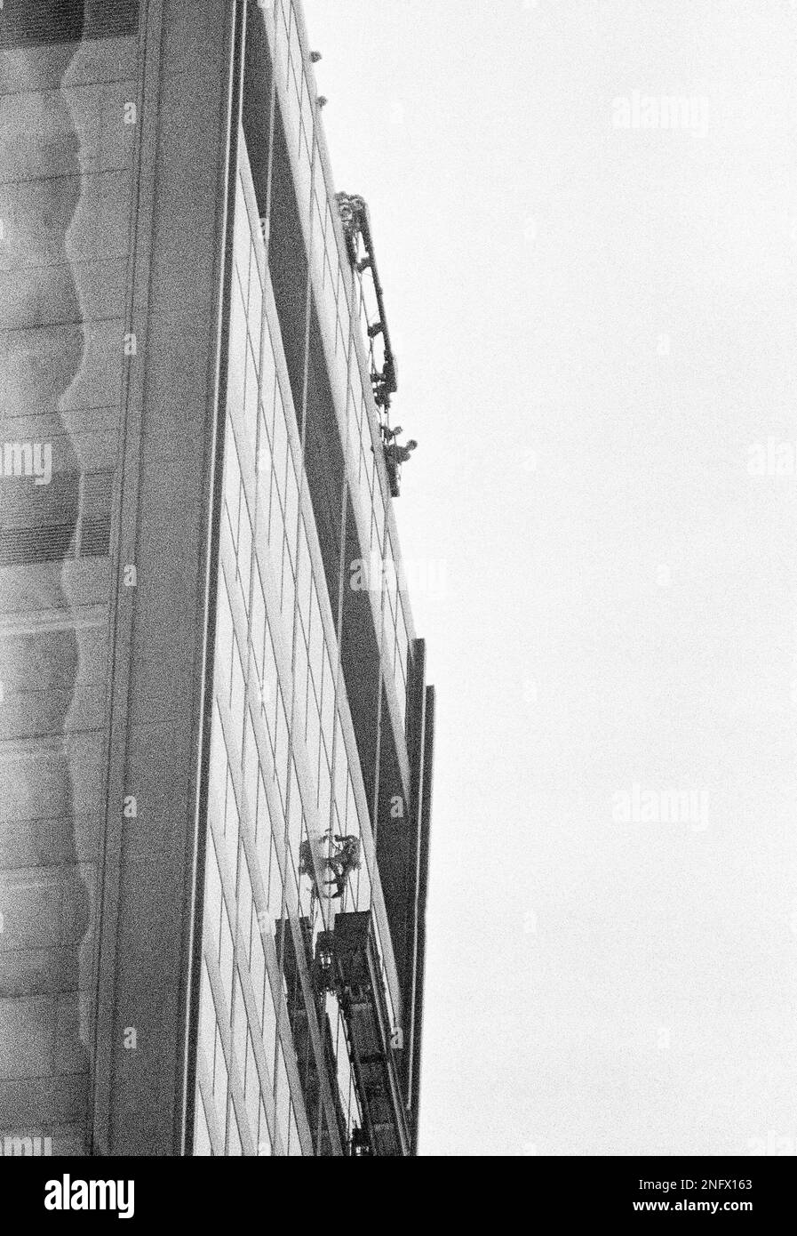 Daniel Goodwin, climber, with a scaffolding following himas ...