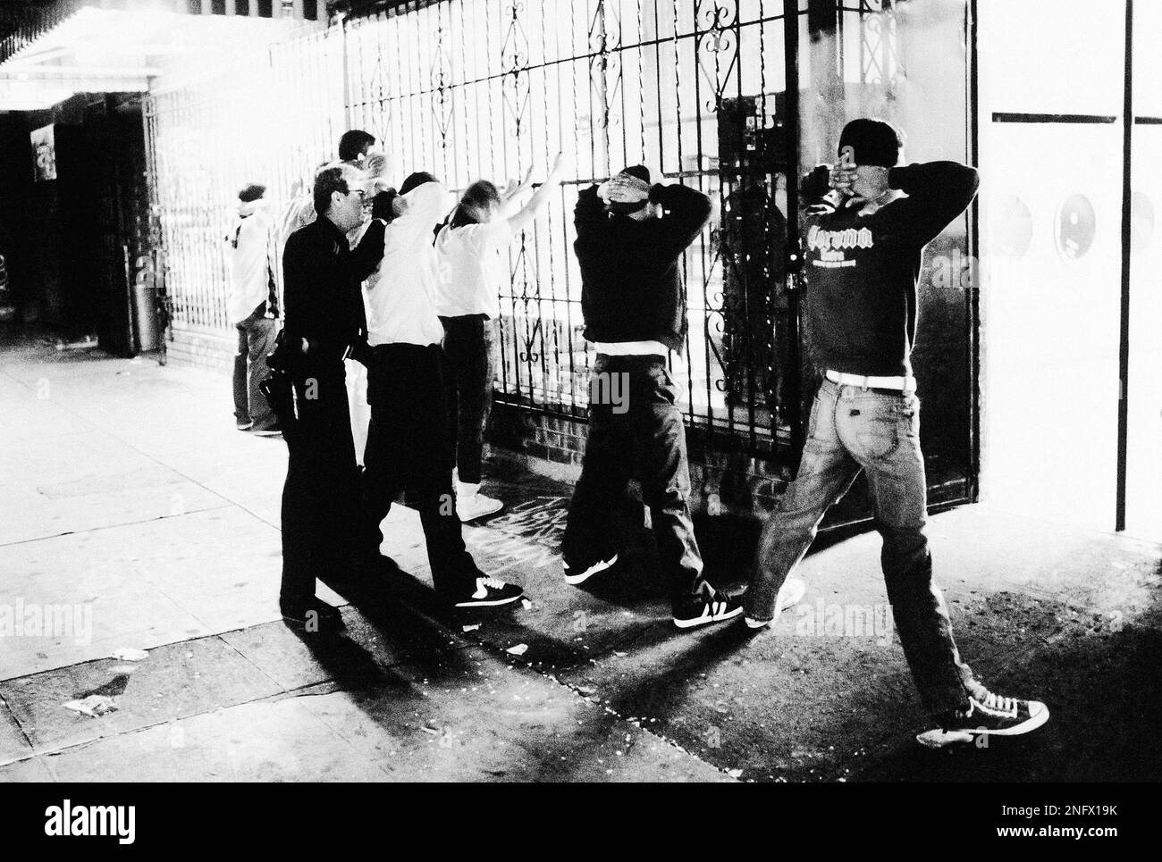 A Los Angeles police officer searches members of the 18th Street gang ...