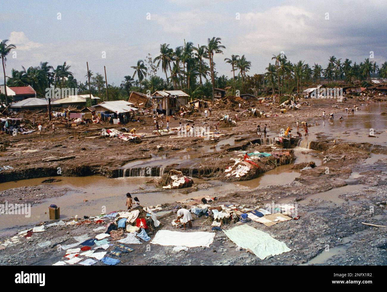 Residents of Ormoc on the island of Leyte, central Philippines, search ...