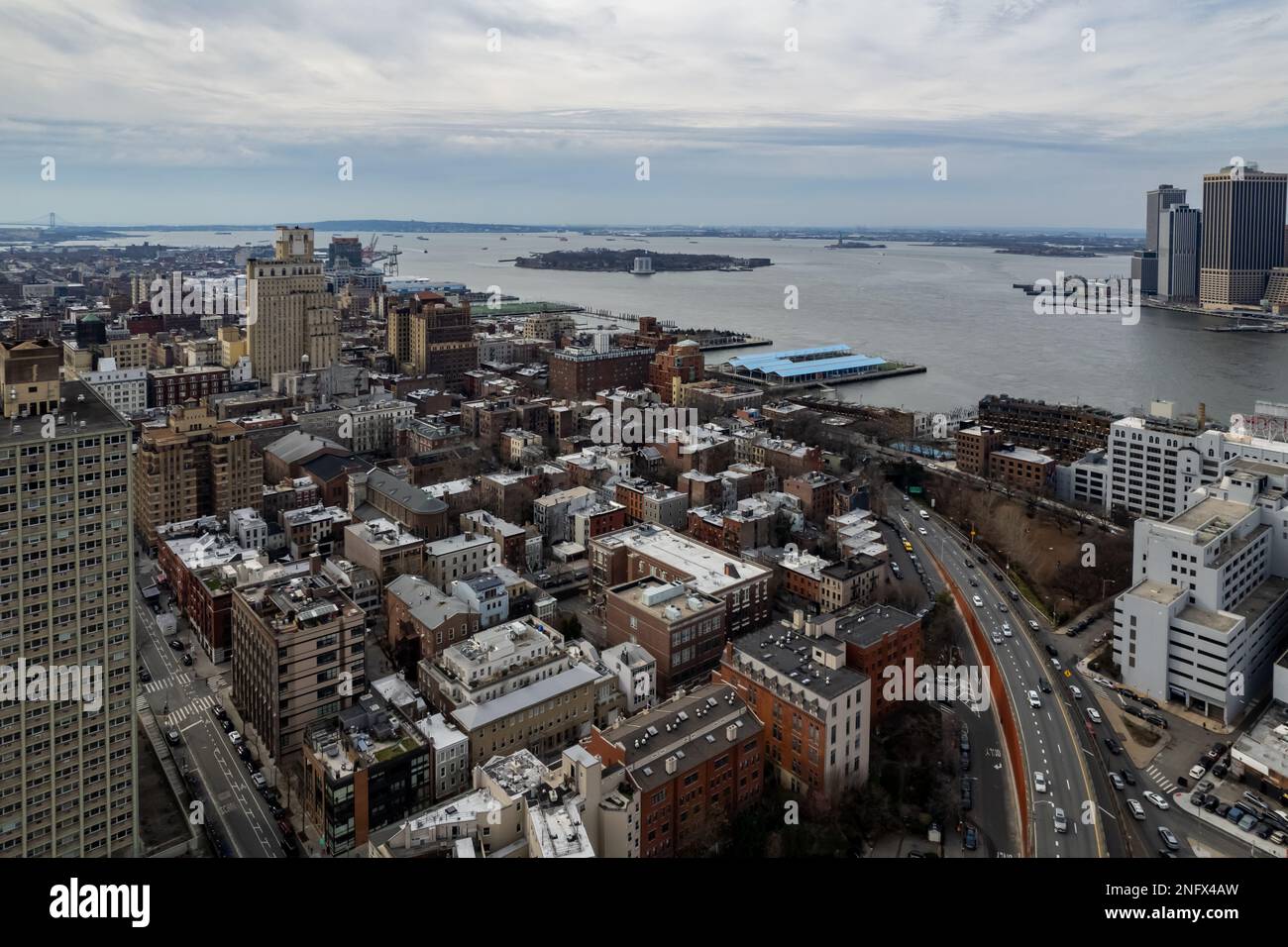 An aerial view of Brooklyn, NY on cloudy day with Governors Island in ...