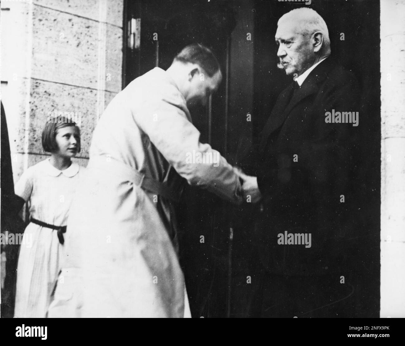 German Reichs chancellor Adolf Hitler, left, bows his head as he shakes ...