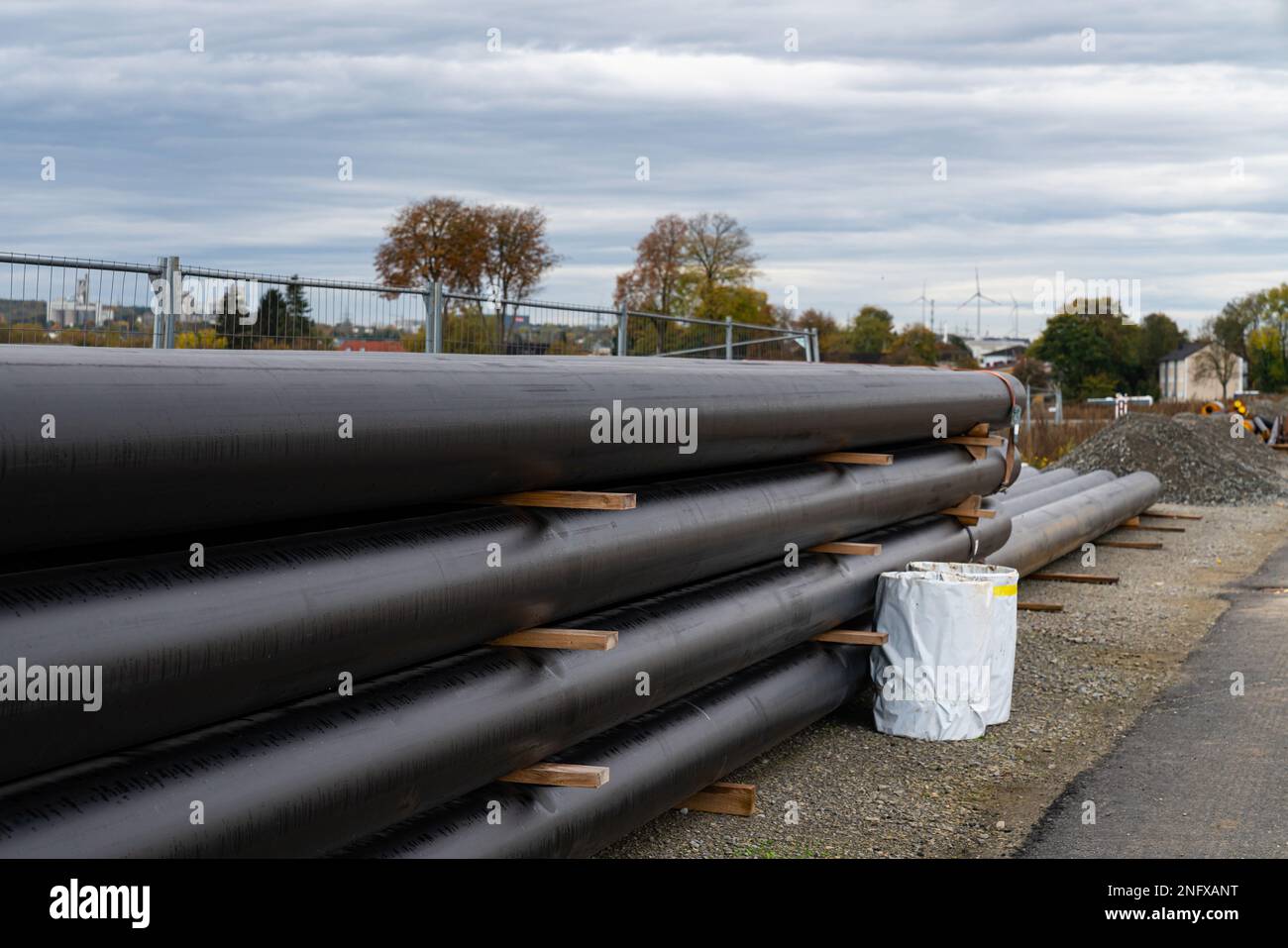 Large black metal pipes with a plastic sheath are laid on the ...