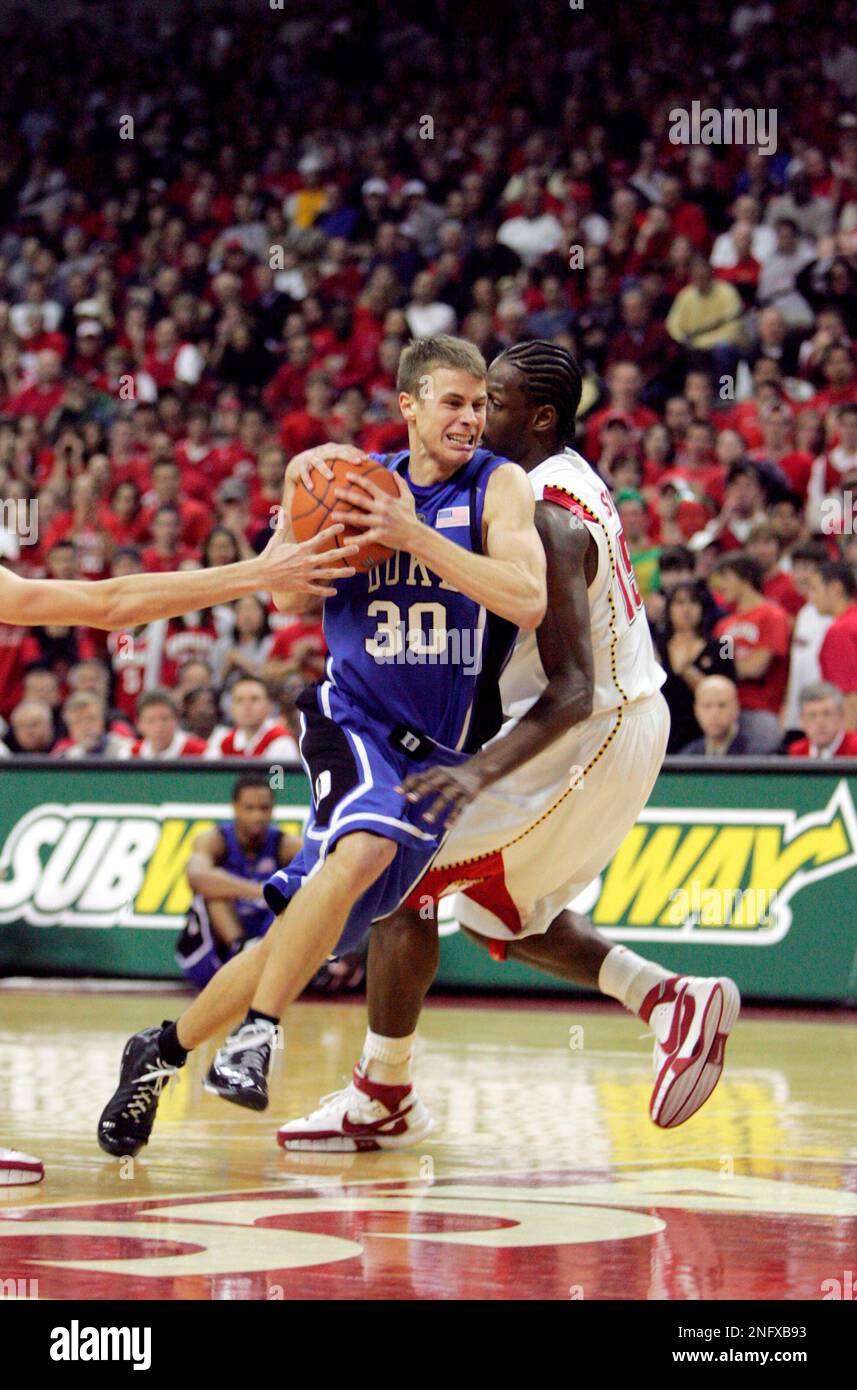 Duke's Jon Scheyer (30) goes to the basket while being guarded by ...