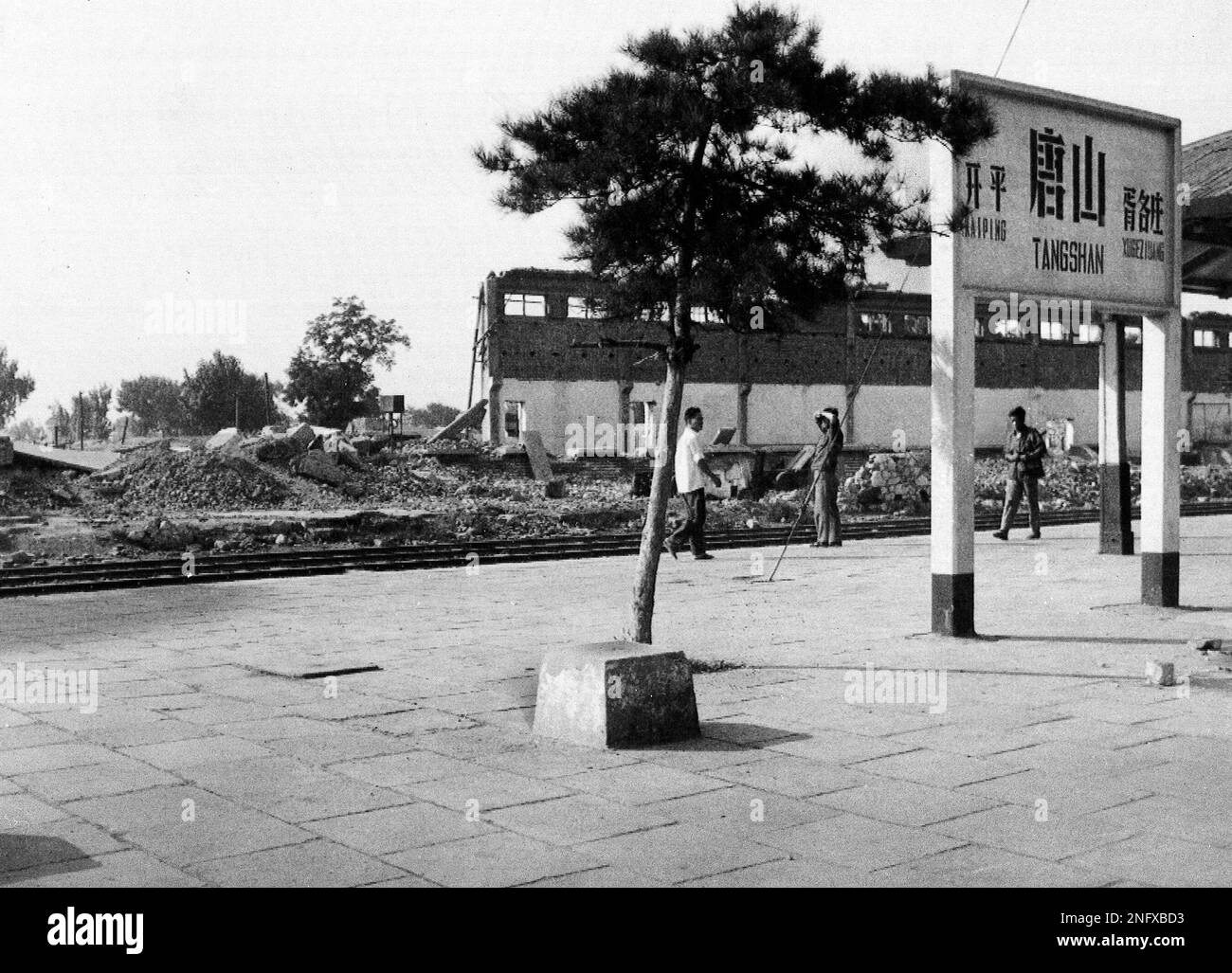 People wait for a train on the platform of the Tangshan station located ...
