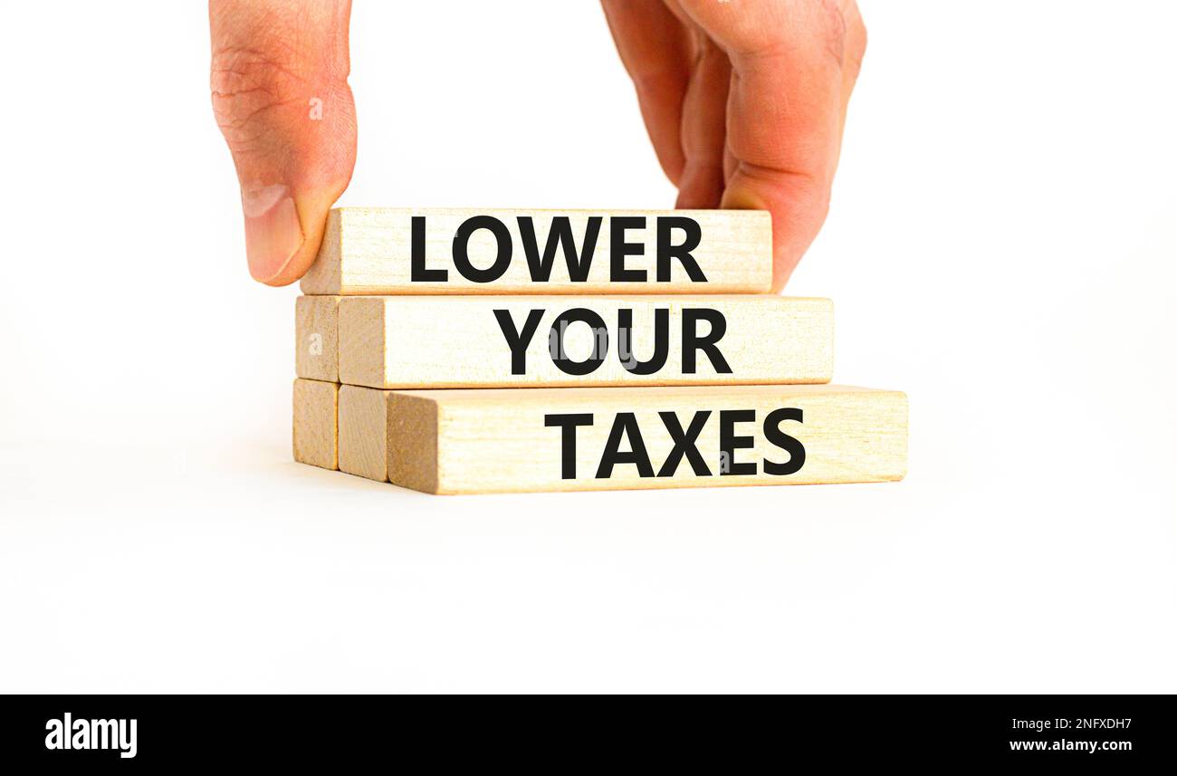 Lower your taxes symbol. Concept words Lower your taxes on wooden ...