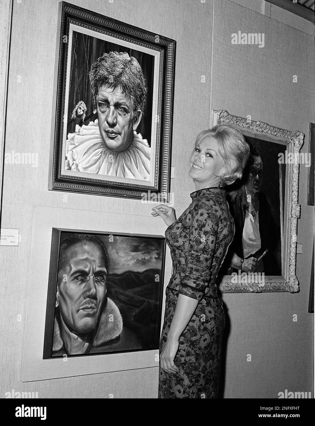 Actress Kim Novak stands beside two of her paintings, "Portrait of ...