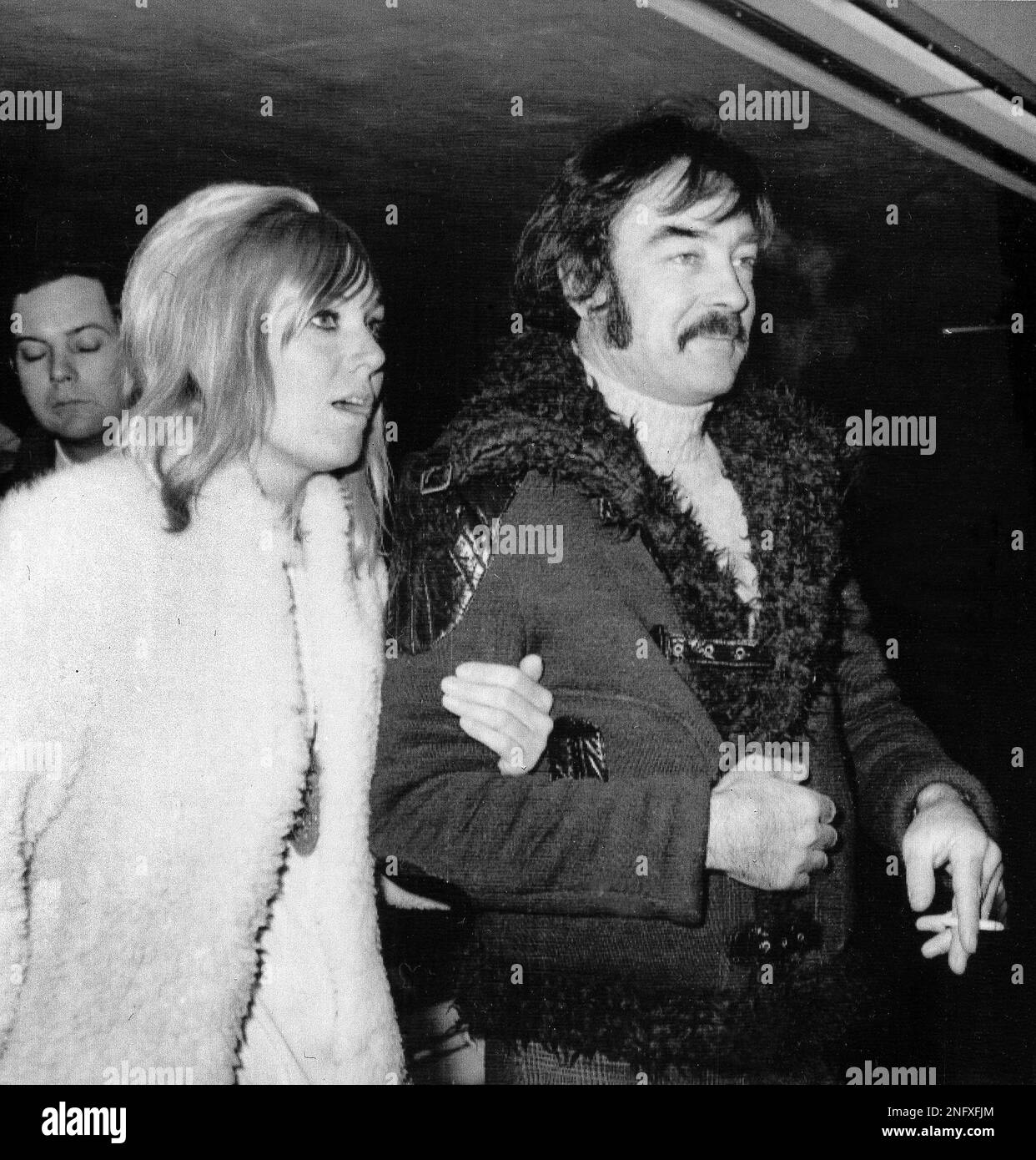 Actress Kim Novak walks arm-in-arm with British actor Richard Johnson ...