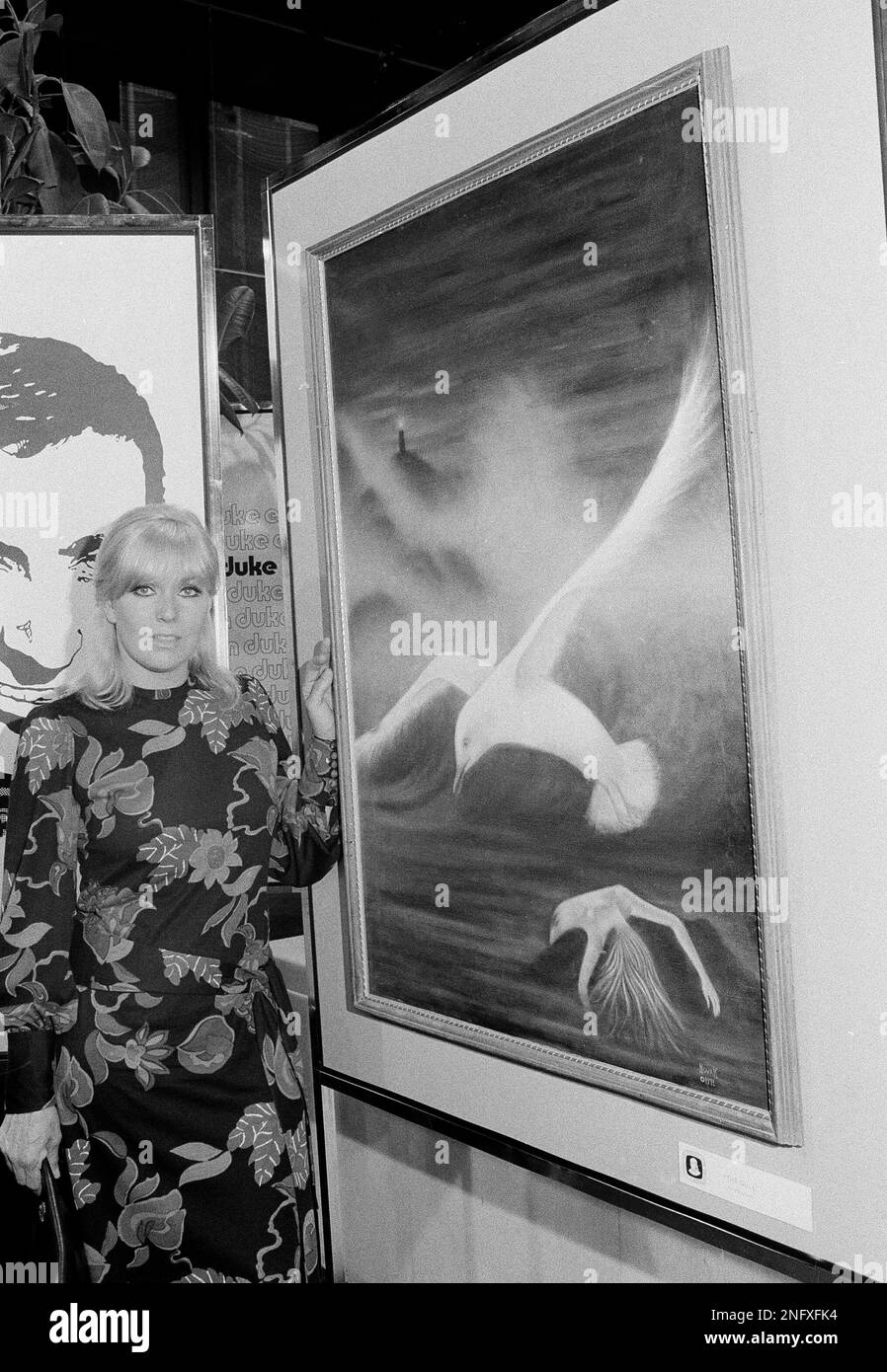Actress Kim Novak stands with her painting, entitled "The Gull," in a ...
