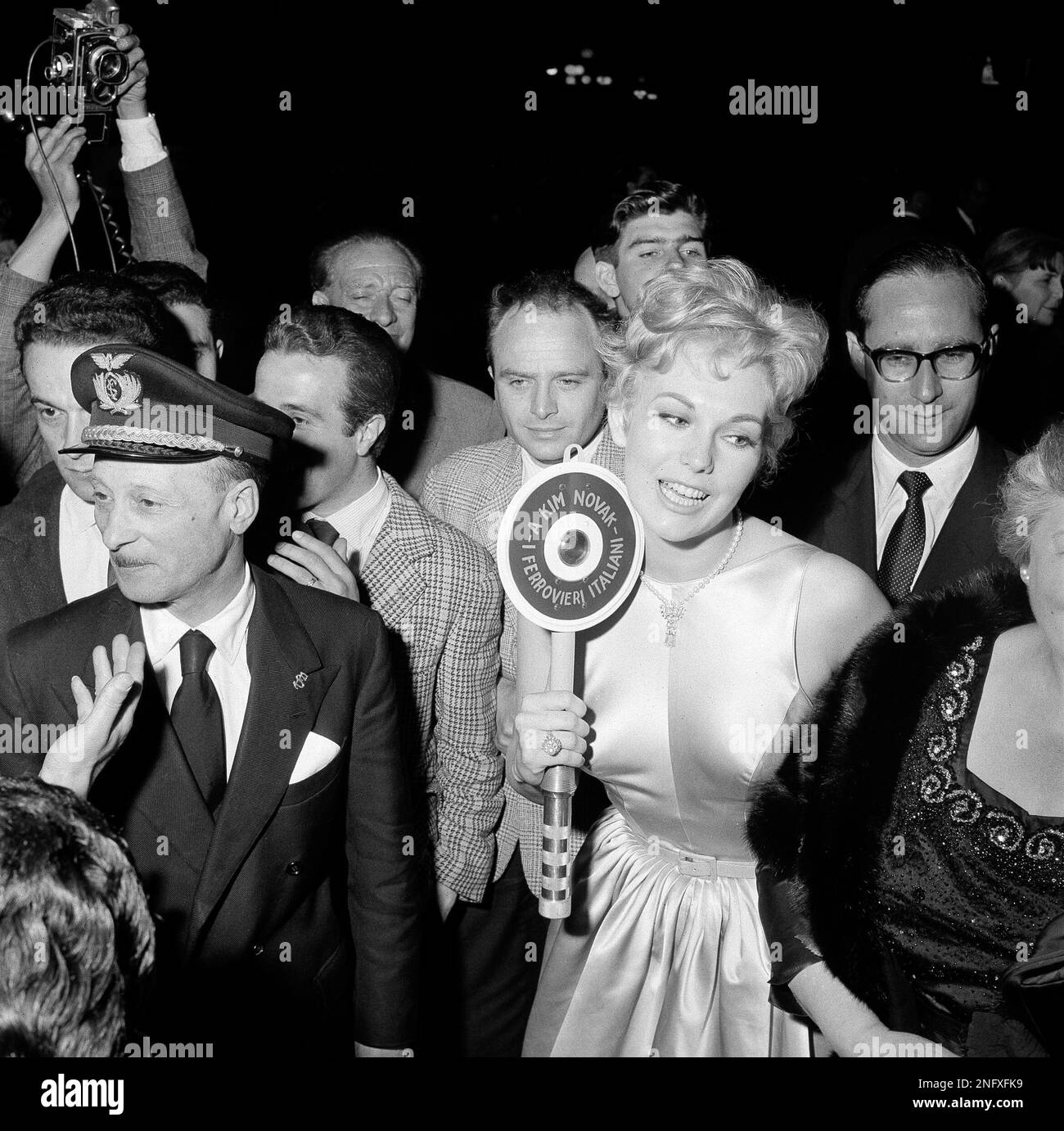 Actress Kim Novak holds a train conductor's signaling disc at Milan's ...