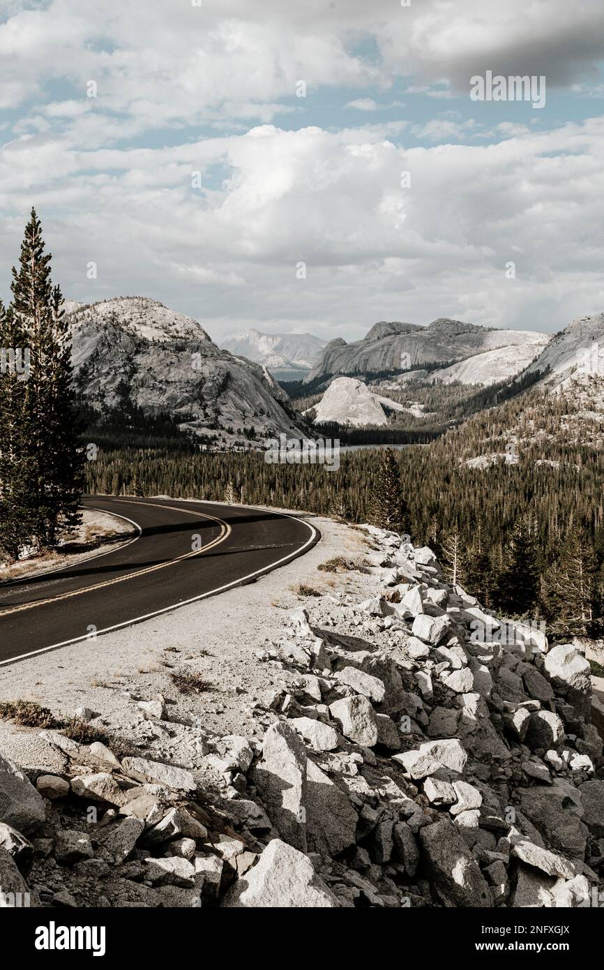 The curve of the route on a mountain road. Surrounded by trees, rocks ...