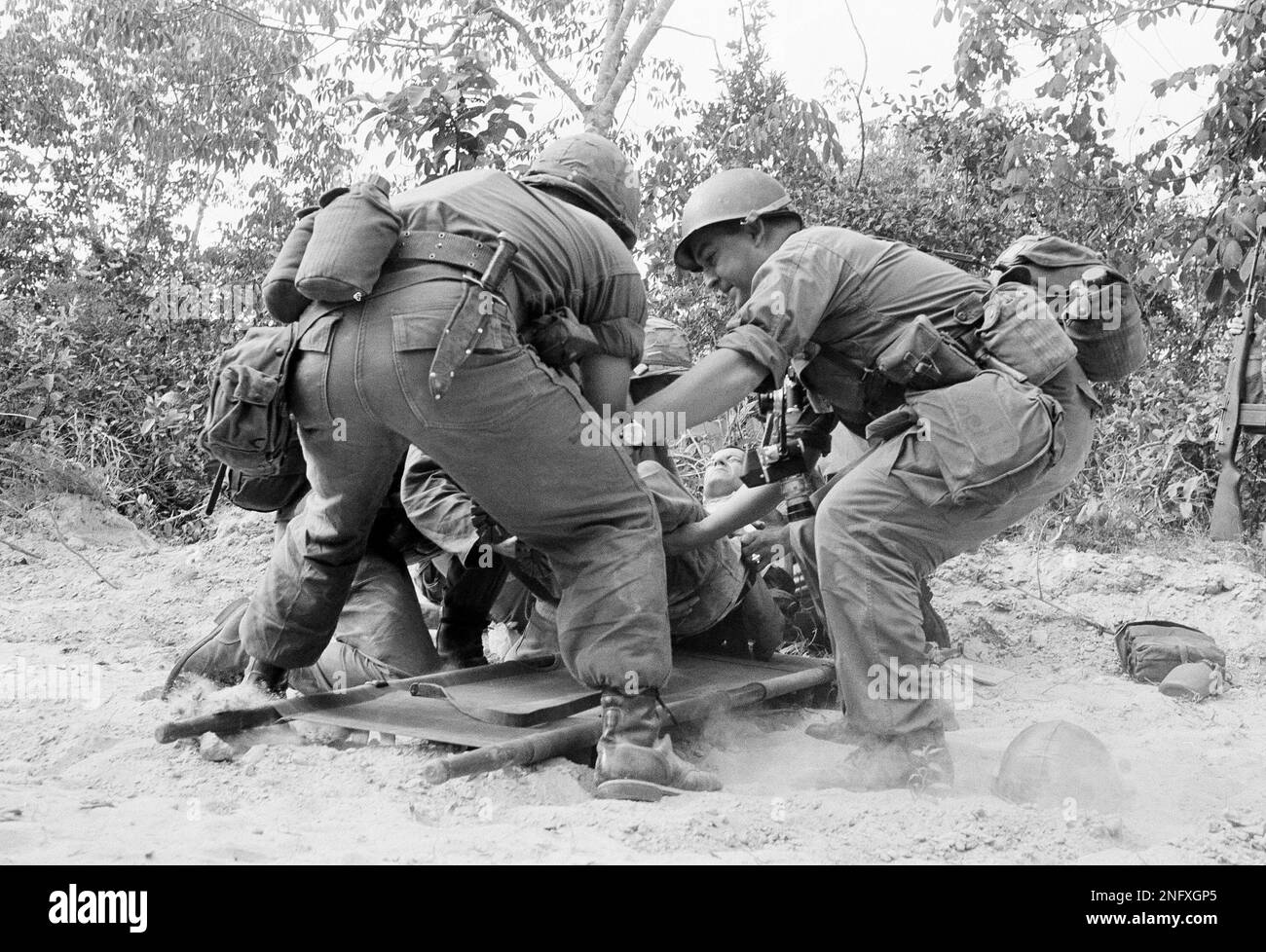 Associated Press photographer Horst Faas, right, and others help lift ...