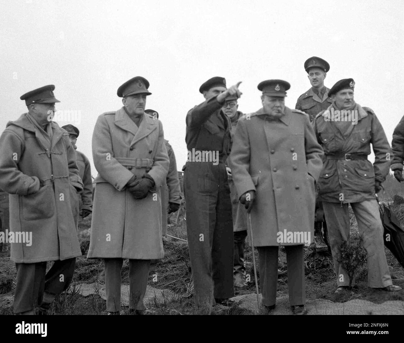 Lieutenant General Guy Simonds, third left, points out a place of ...