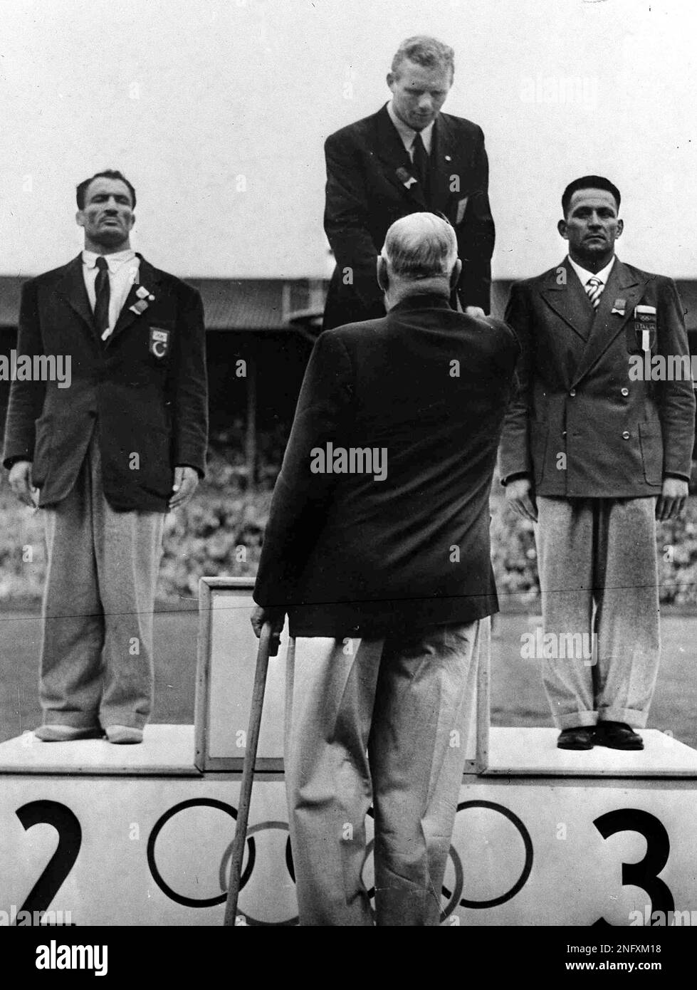 Sweden's Axel Gronberg, top, receives his winner's medal in the men's ...