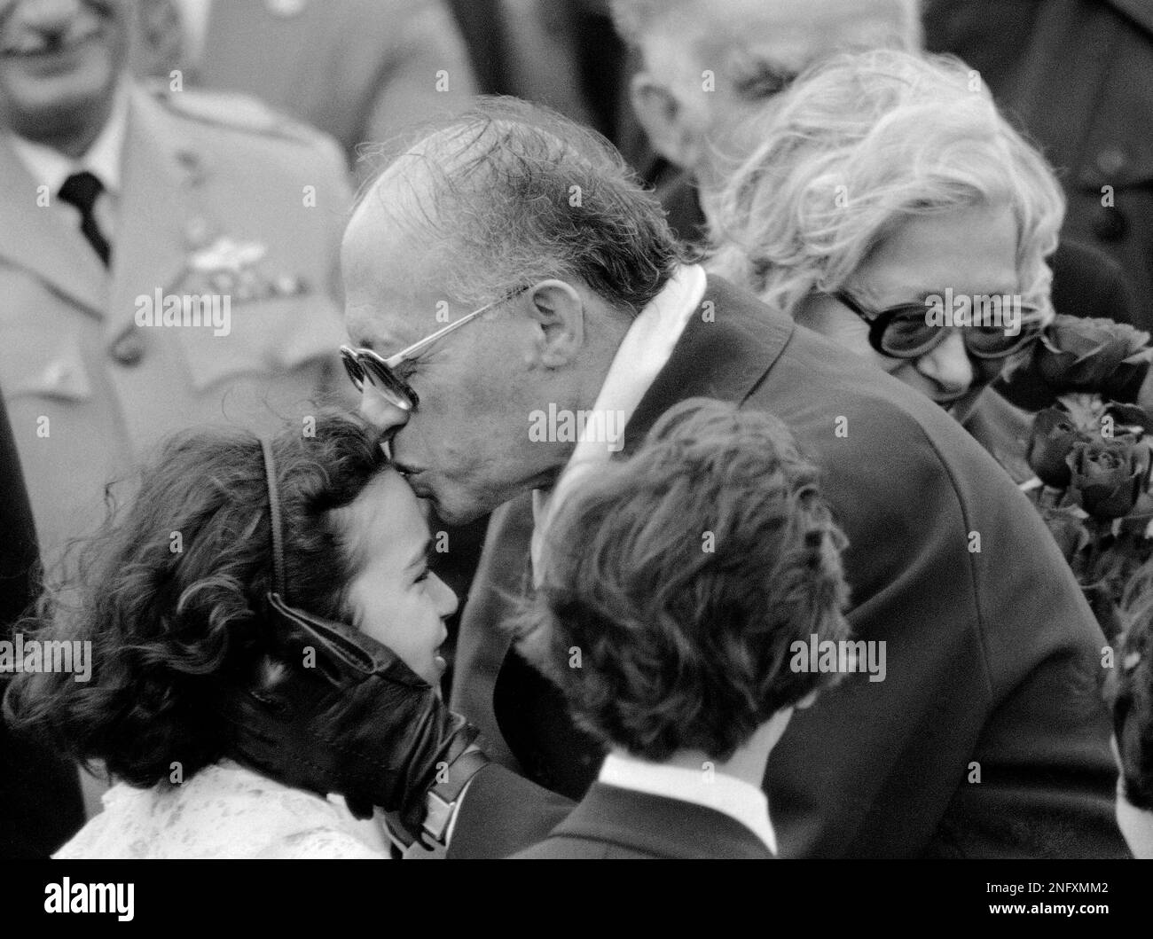 Israeli Prime Minister Menachem Begin kisses a child who was with a ...