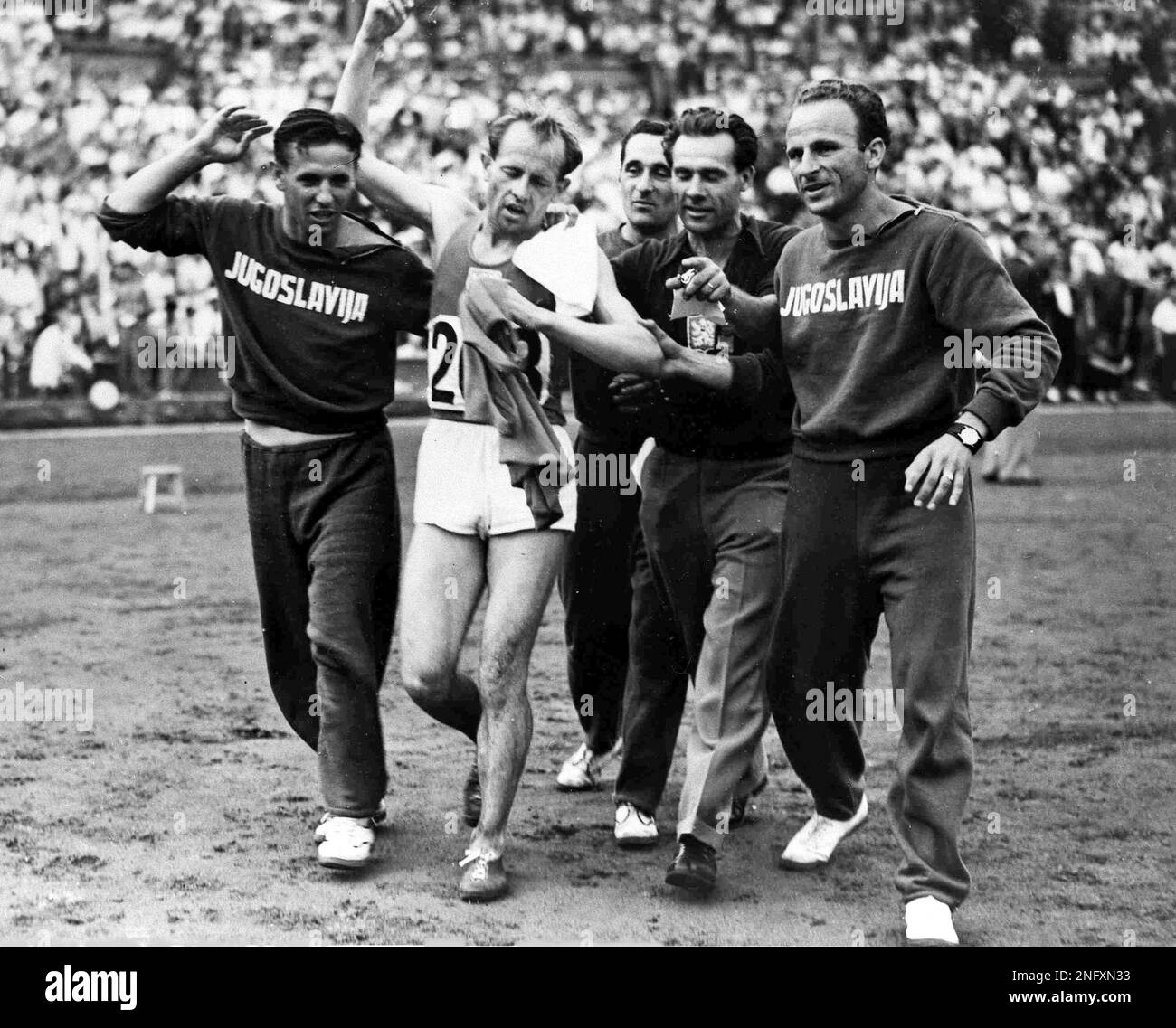 Czechoslovakia's Emil Zatopek gets a helping hand from Yugoslavian ...