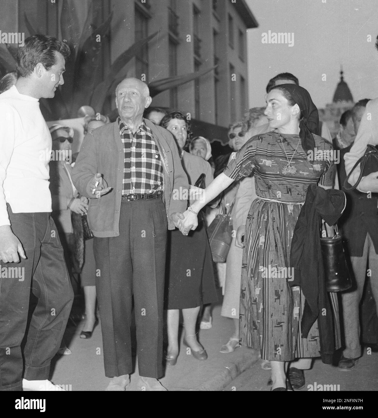 Artist Pablo Picasso and his model Jacqueline Roque stroll hand in hand ...