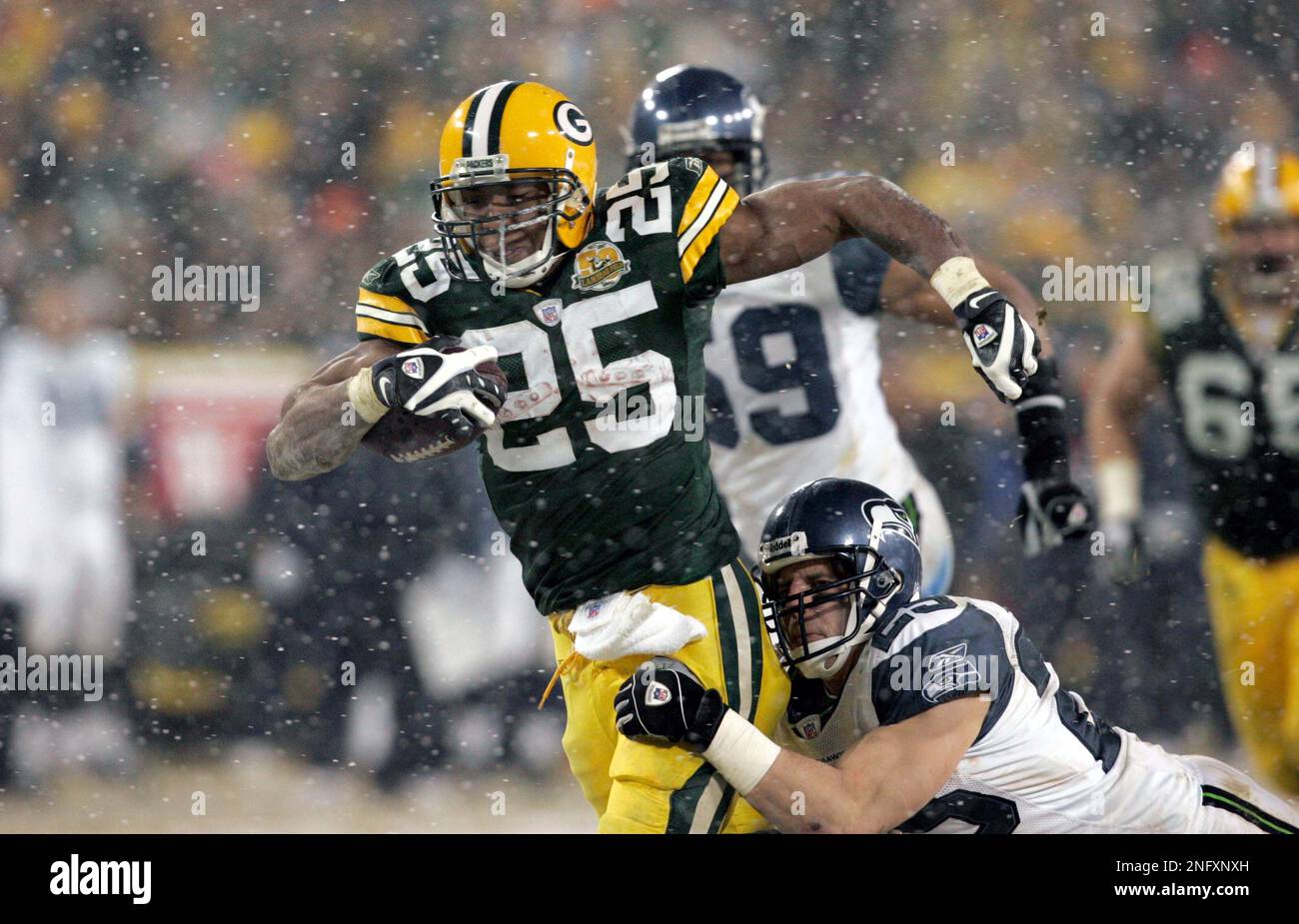 Green Bay Packers running back Ryan Grant (25) is grabbed from behind ...