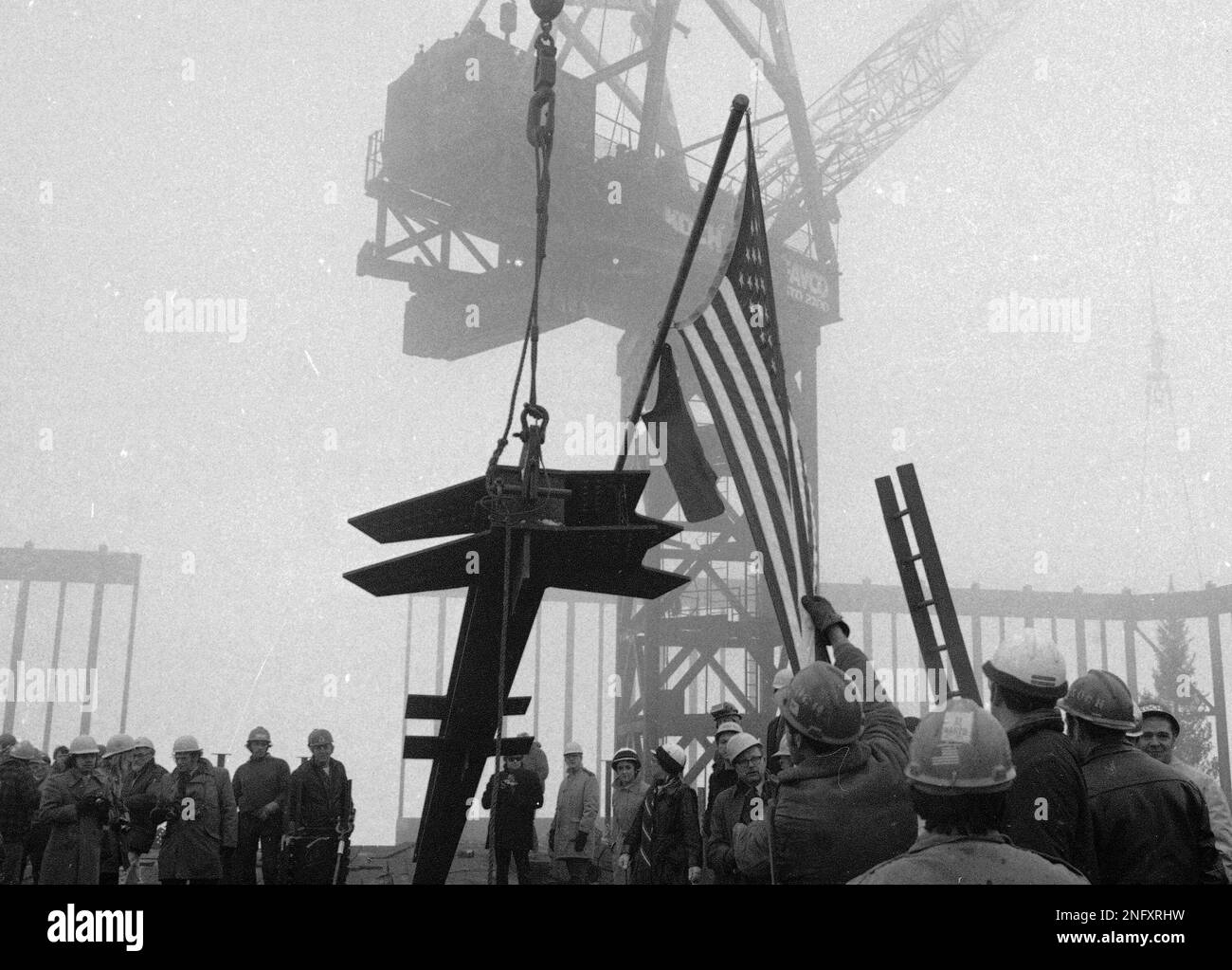 A 36-foot long, 4-ton column is hoisted atop the new world's tallest ...