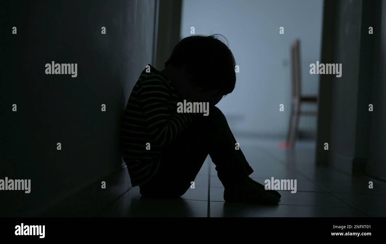Small child covering face feeling despair. One small boy sitting in ...