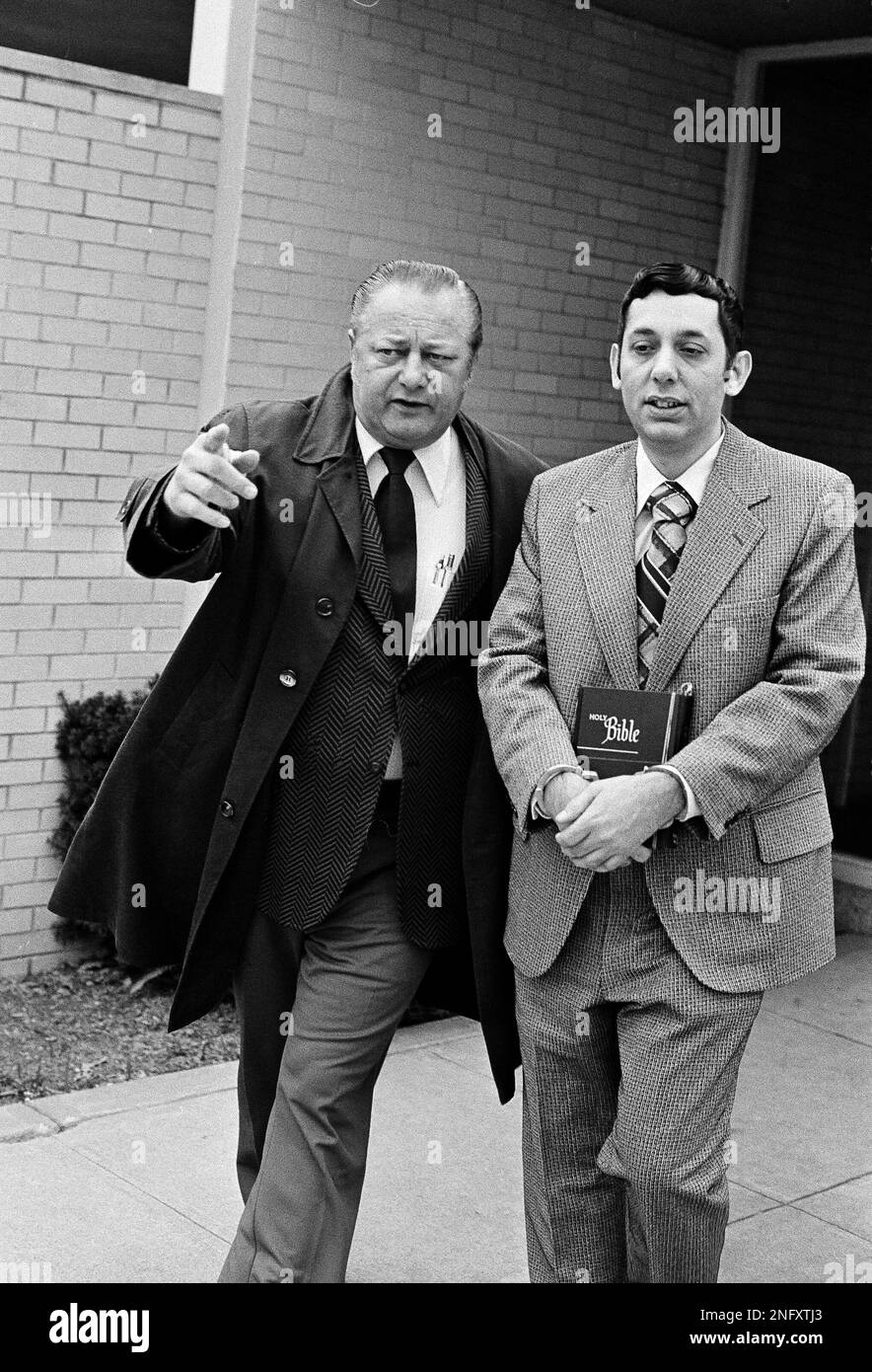 Joseph Kallinger of Philadelphia, wearing a business suit and carrying ...