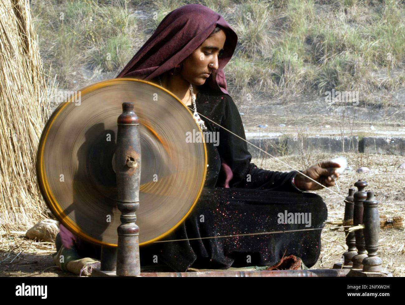 A nomadic woman makes threads for weaving in the outskirts of Jammu ...