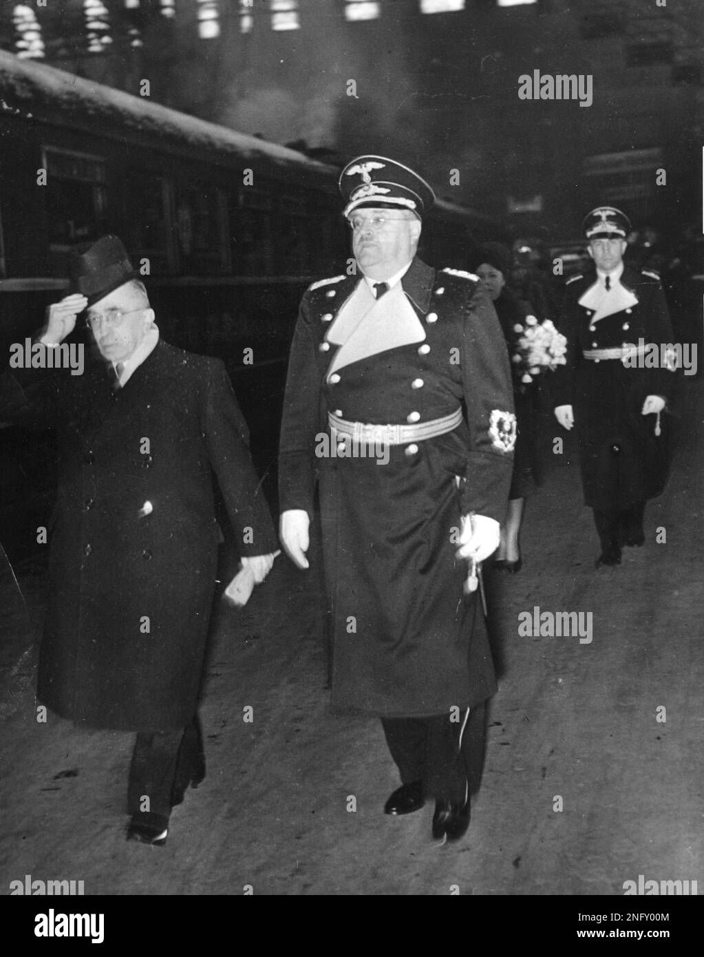 Czech President Emil Hacha, left, adjusts his hat as he leaves Berlin ...