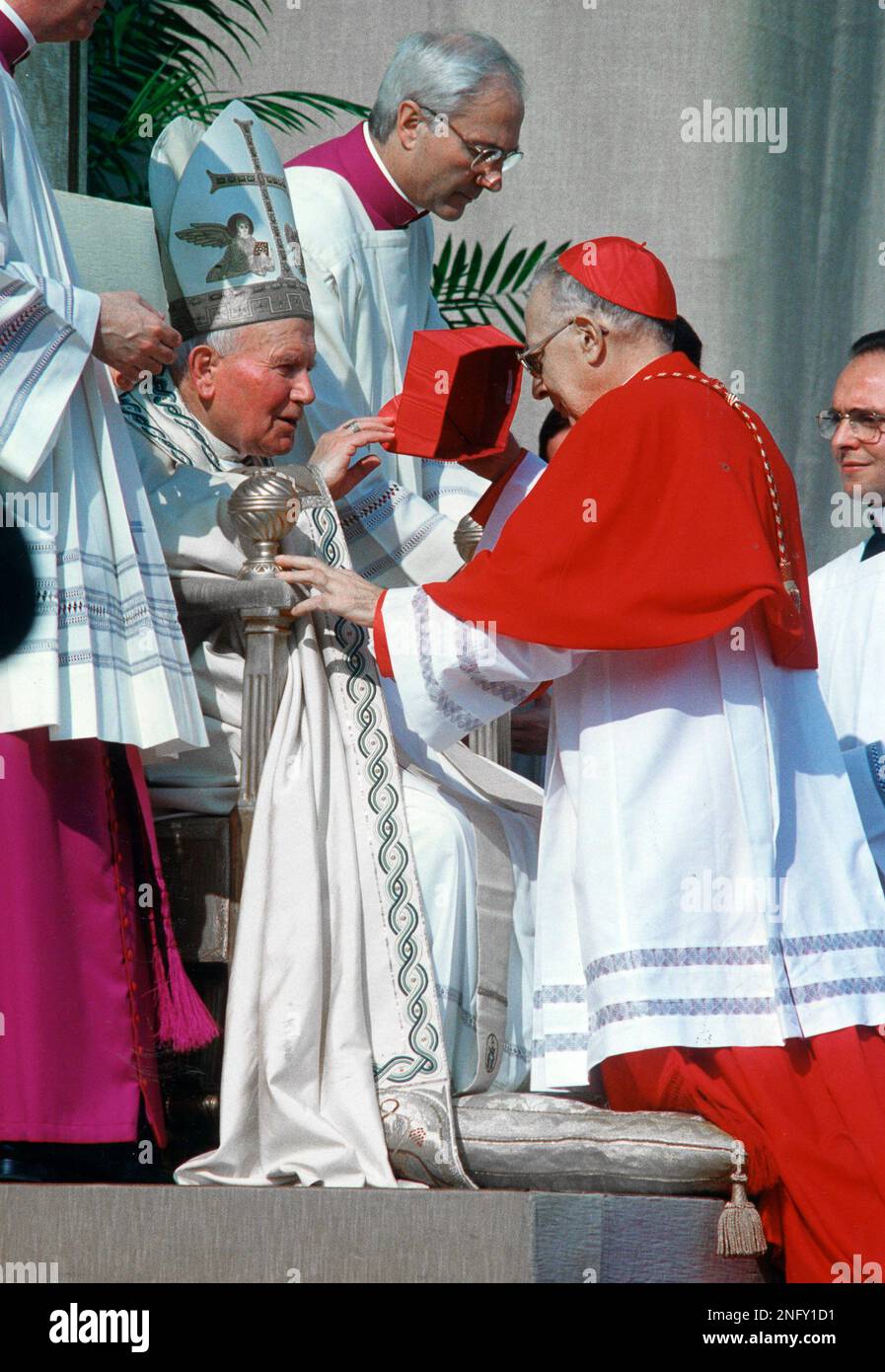Cardinal Jean Balland of Lyon, France, kneels in front of Pope John Paul II in this undated ...