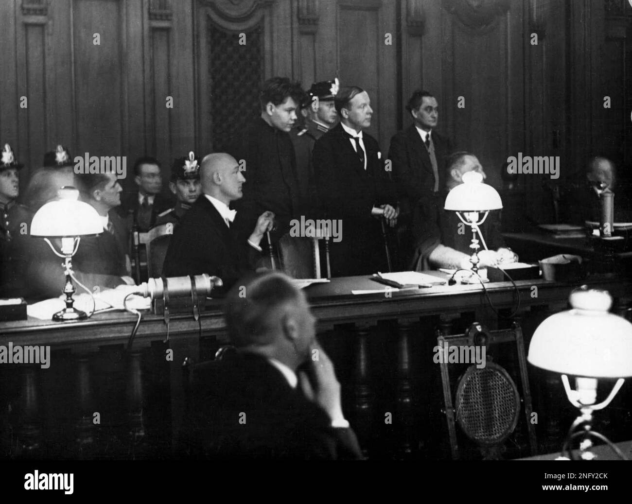 Standing, from left to right: Marinus van der Lubbe, his interpreter ...