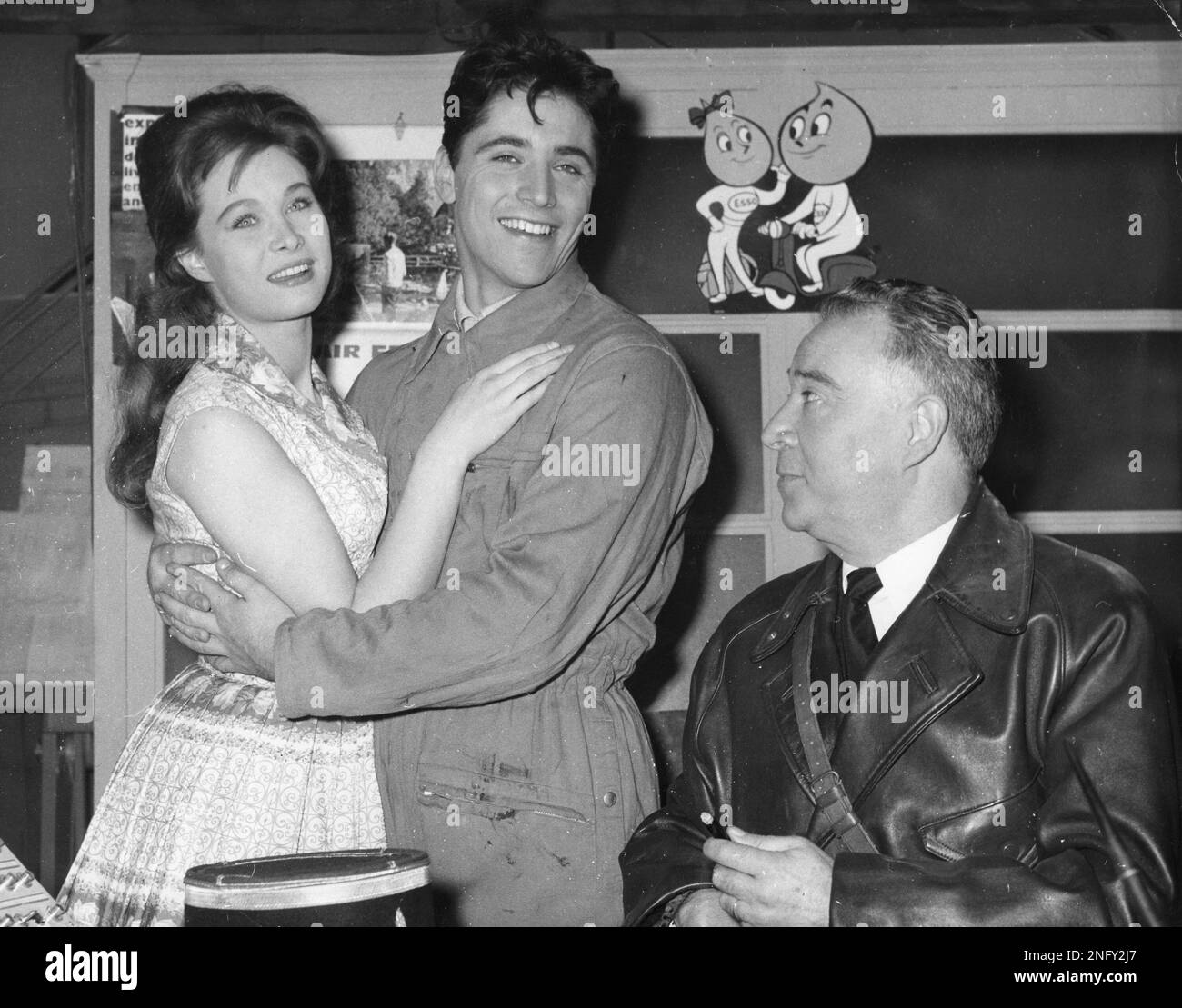 French singer Sacha Distel, center, is pictured at the set hugging ...