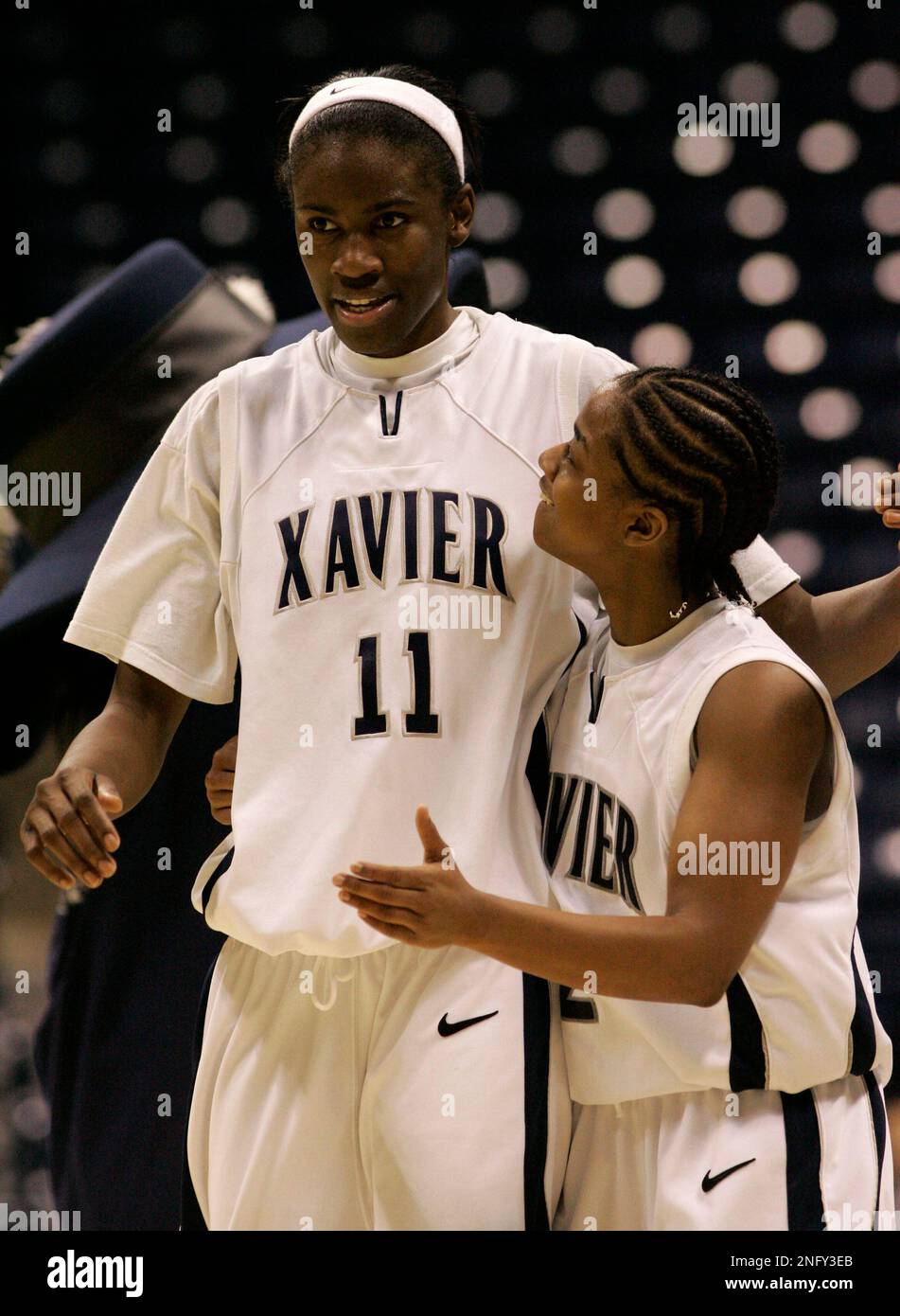 Xavier forward Amber Harris (11) walks off the court with teammate ...