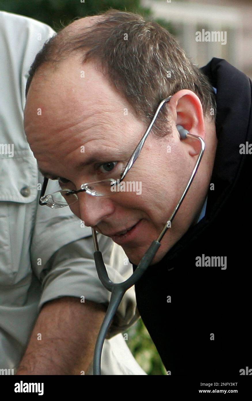 Prince Albert II of Monaco, checks the breathing of a sedated leopard ...