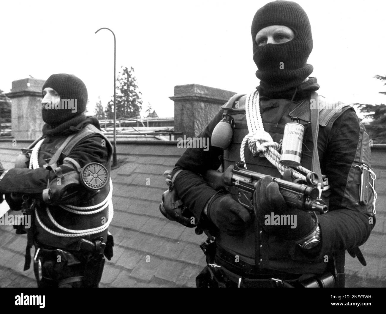 Two hooded actors, dressed and equipped as soldiers of Britain's ...
